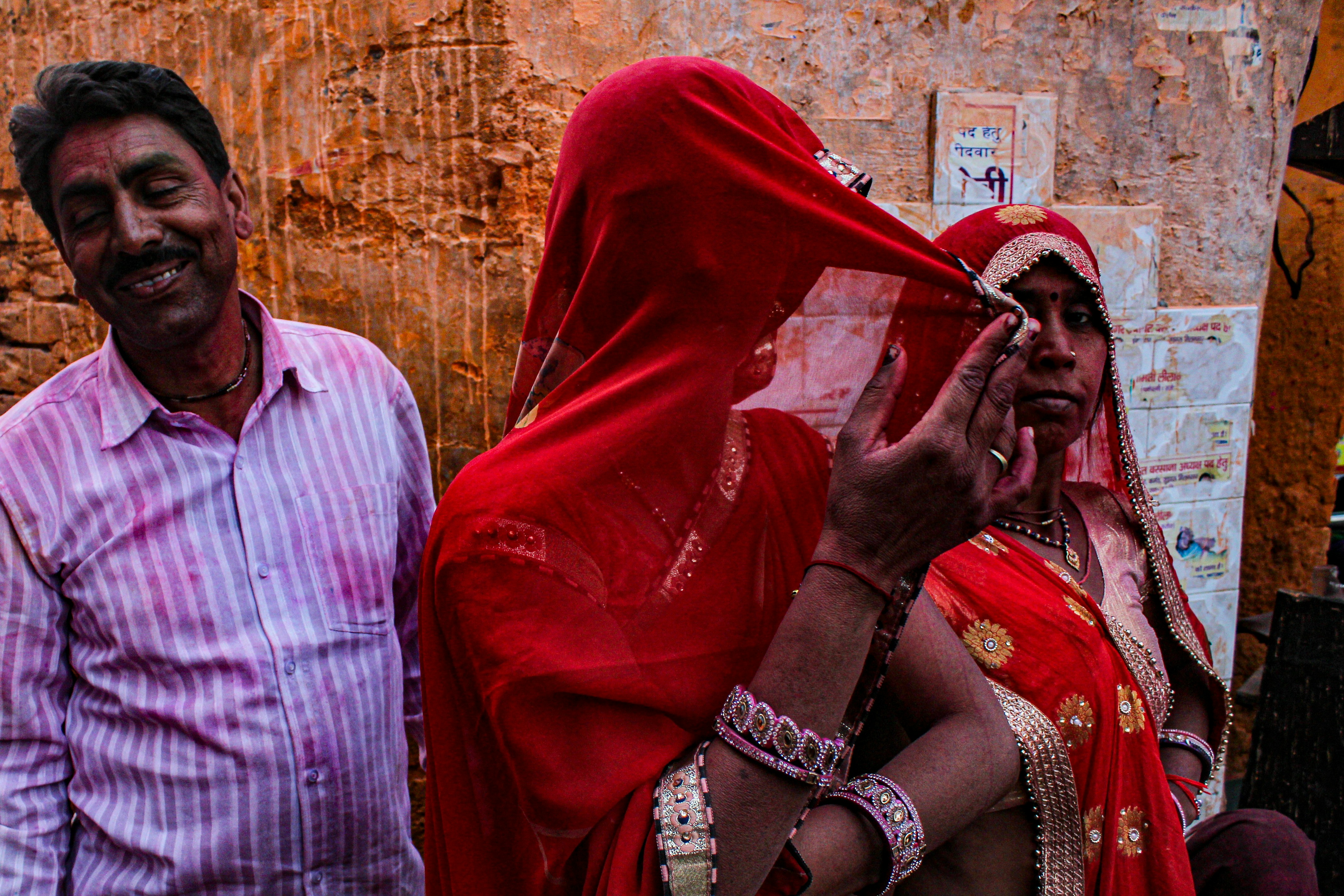 Man in red robe holding red textile photo – Free Apparel Image on Unsplash