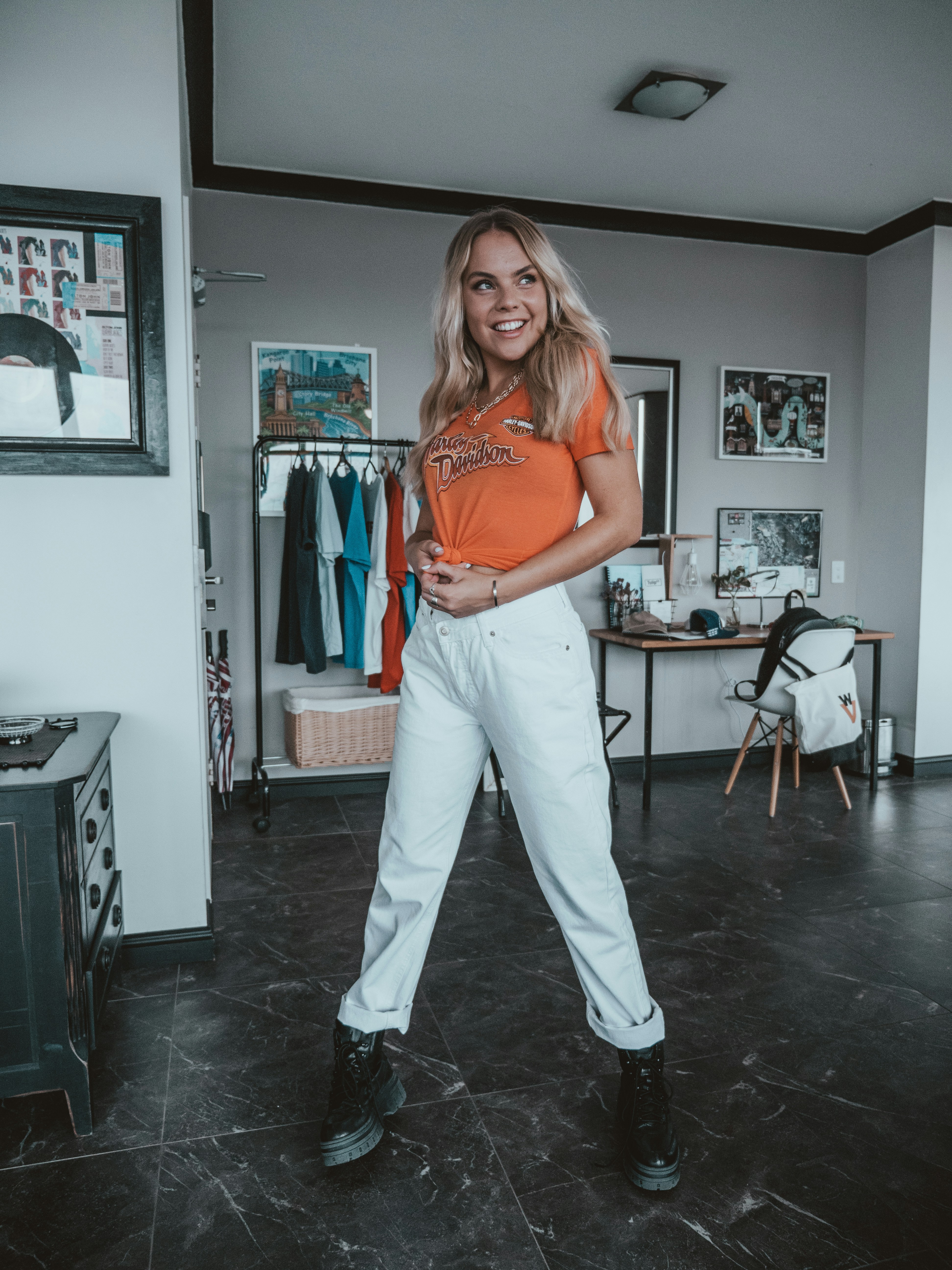 Orange Pop Portrait: Studio Confidence Among Wardrobe Walls