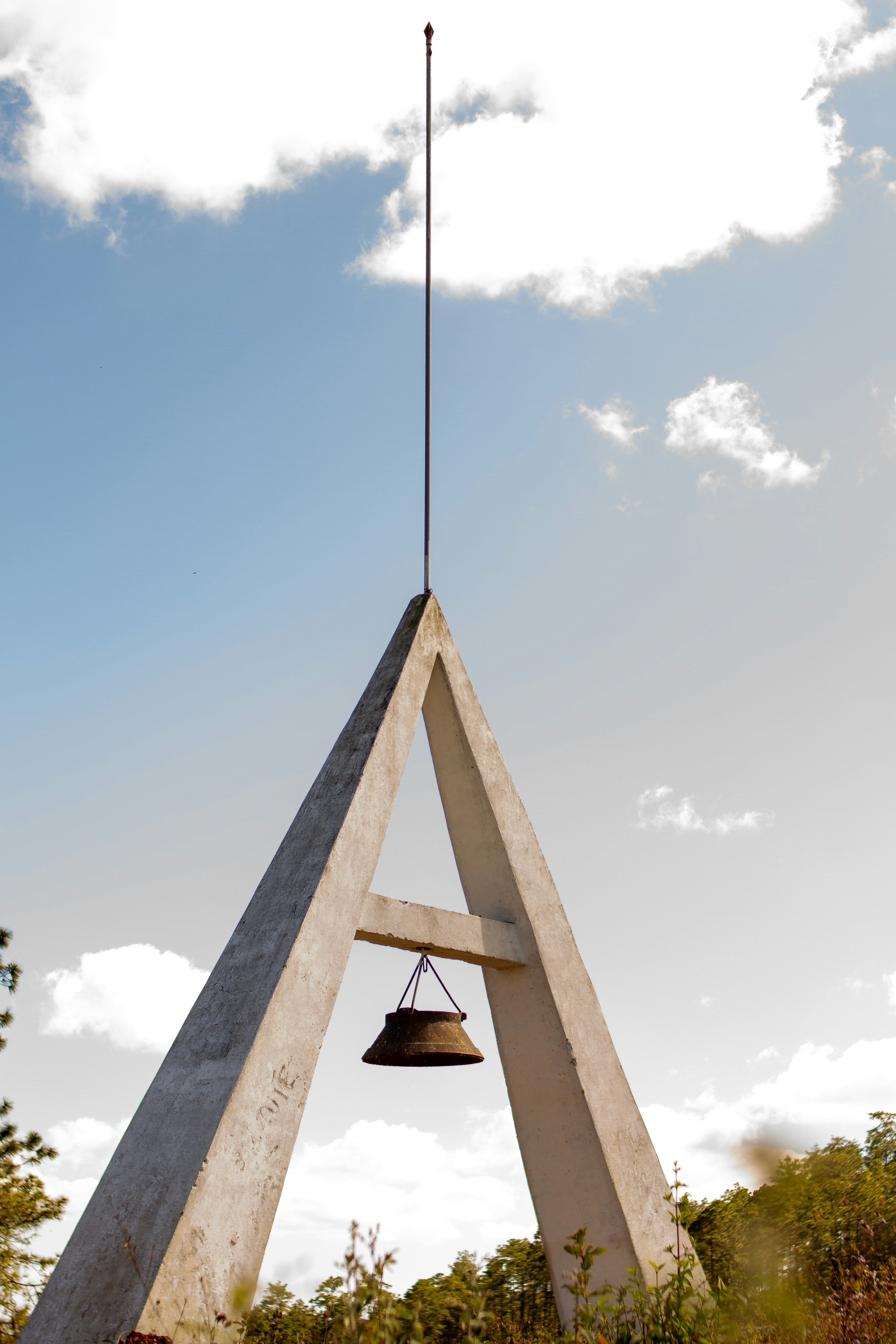Apex Bell in a Concrete Triangle Under a Clear Sky