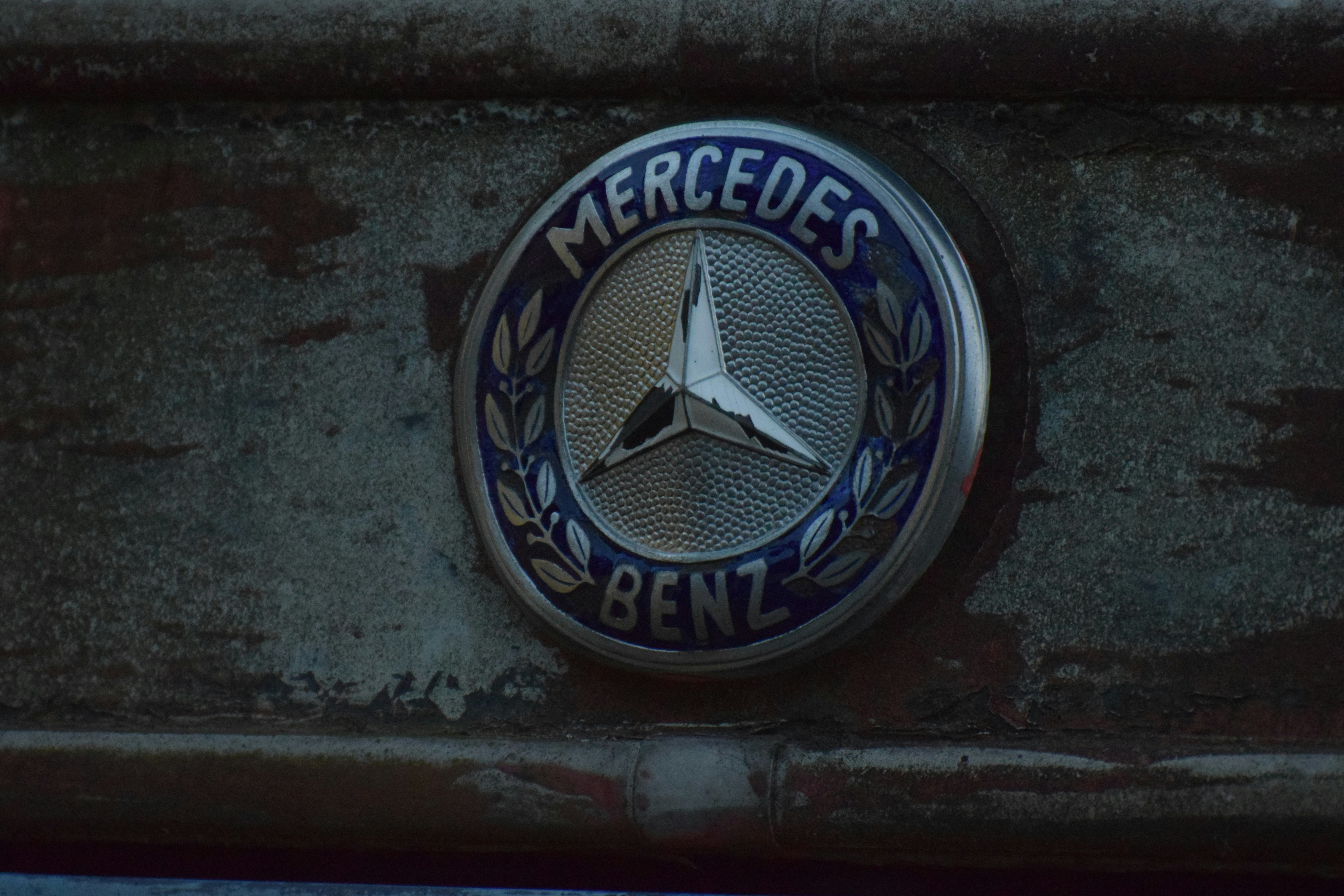 A mercedes emblem on the side of a building photo – Free Grey Image on ...