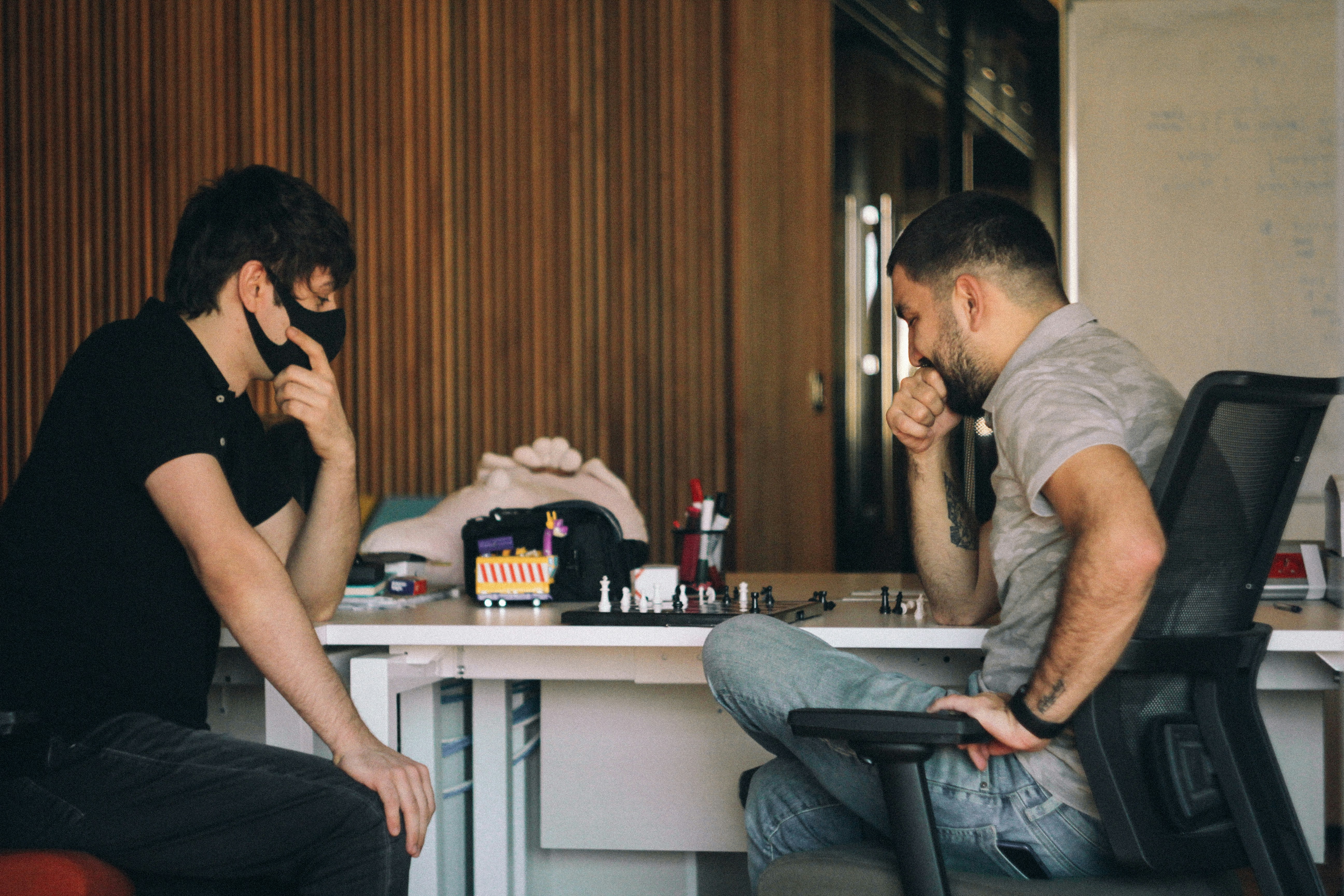 Focused Exchange at a Cluttered Studio Desk