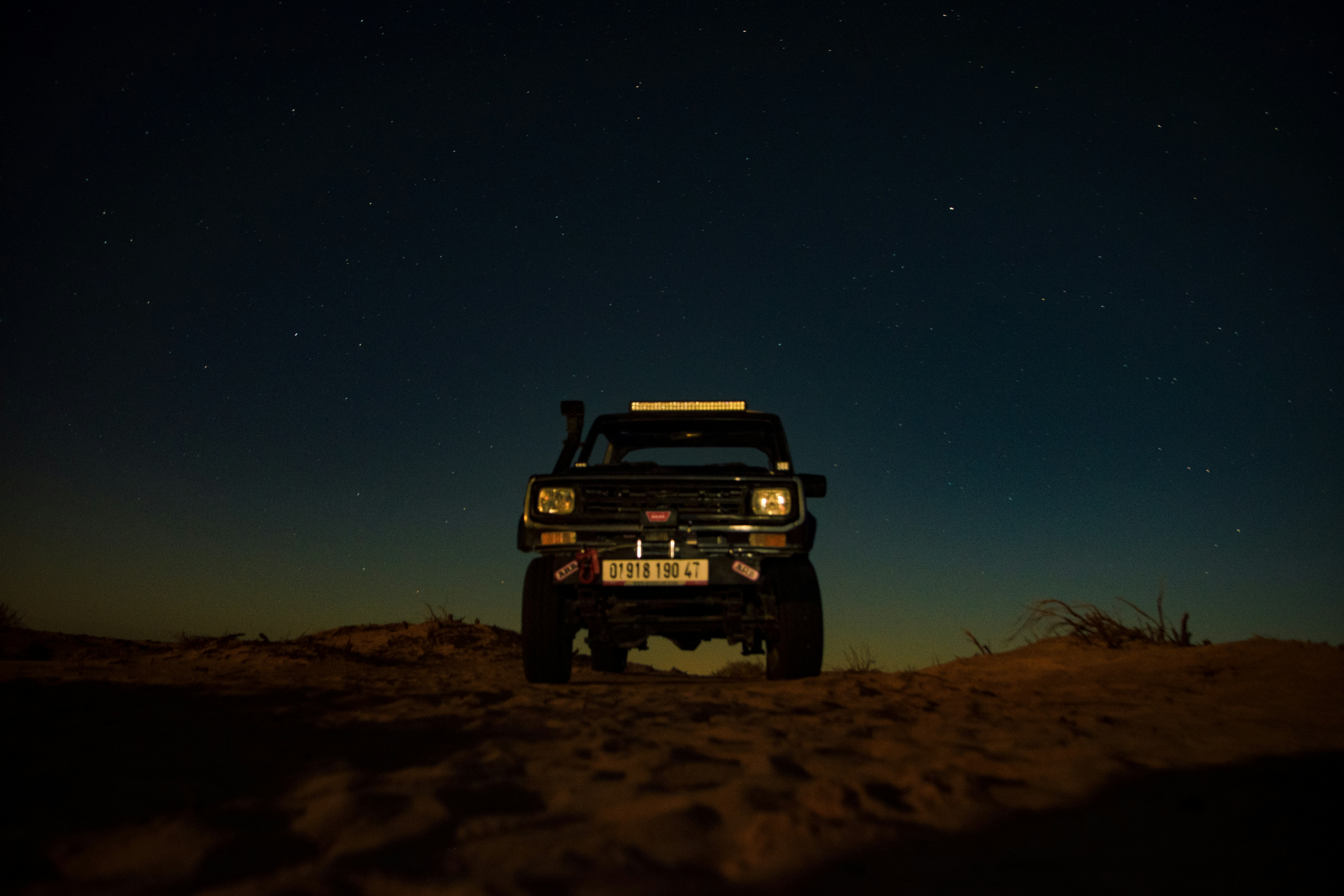 Black suv on brown field during night time photo – Free Black Image on ...