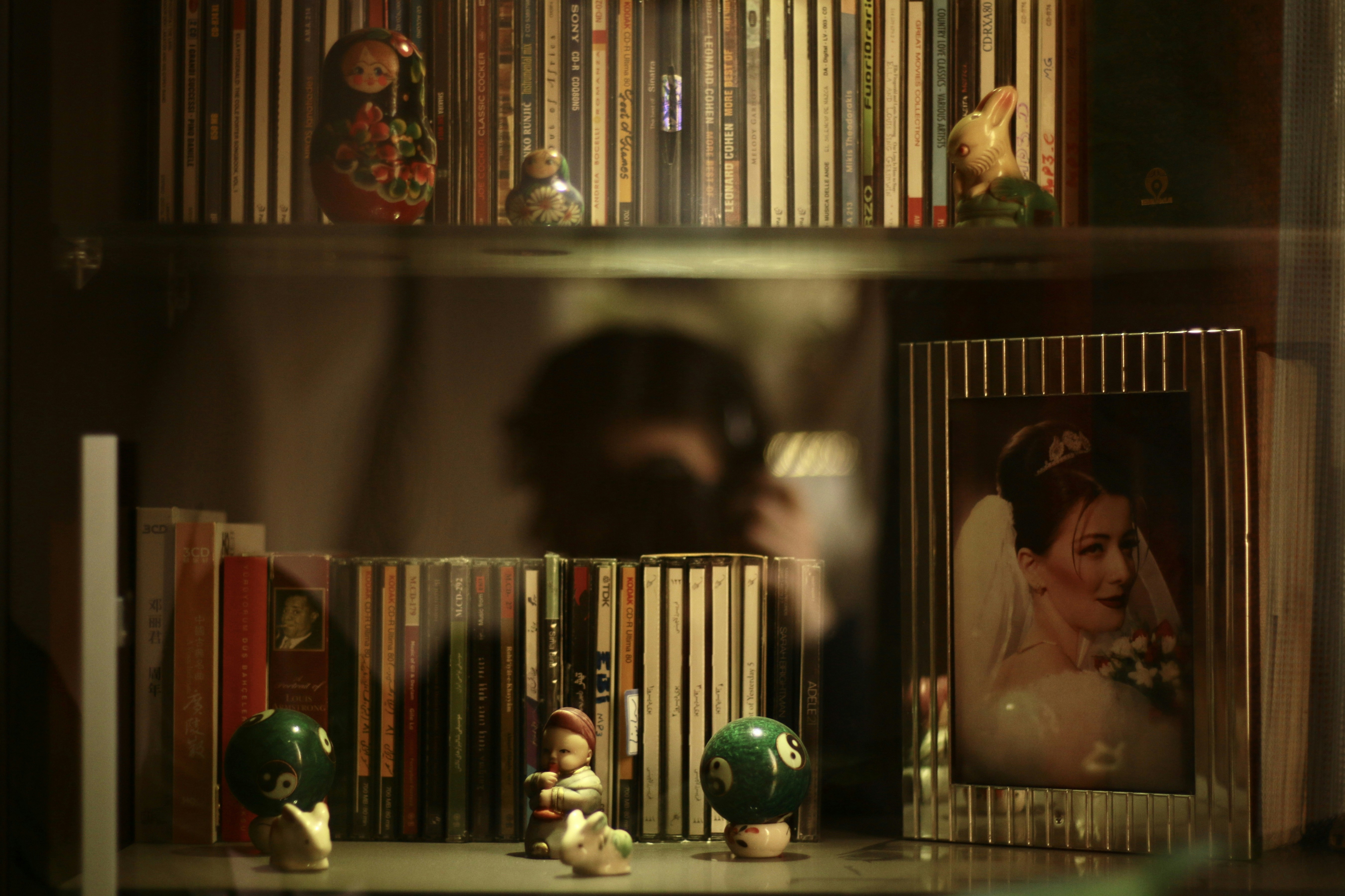 Bride in the Shelf: A Quiet Portrait Among Books and Figurines