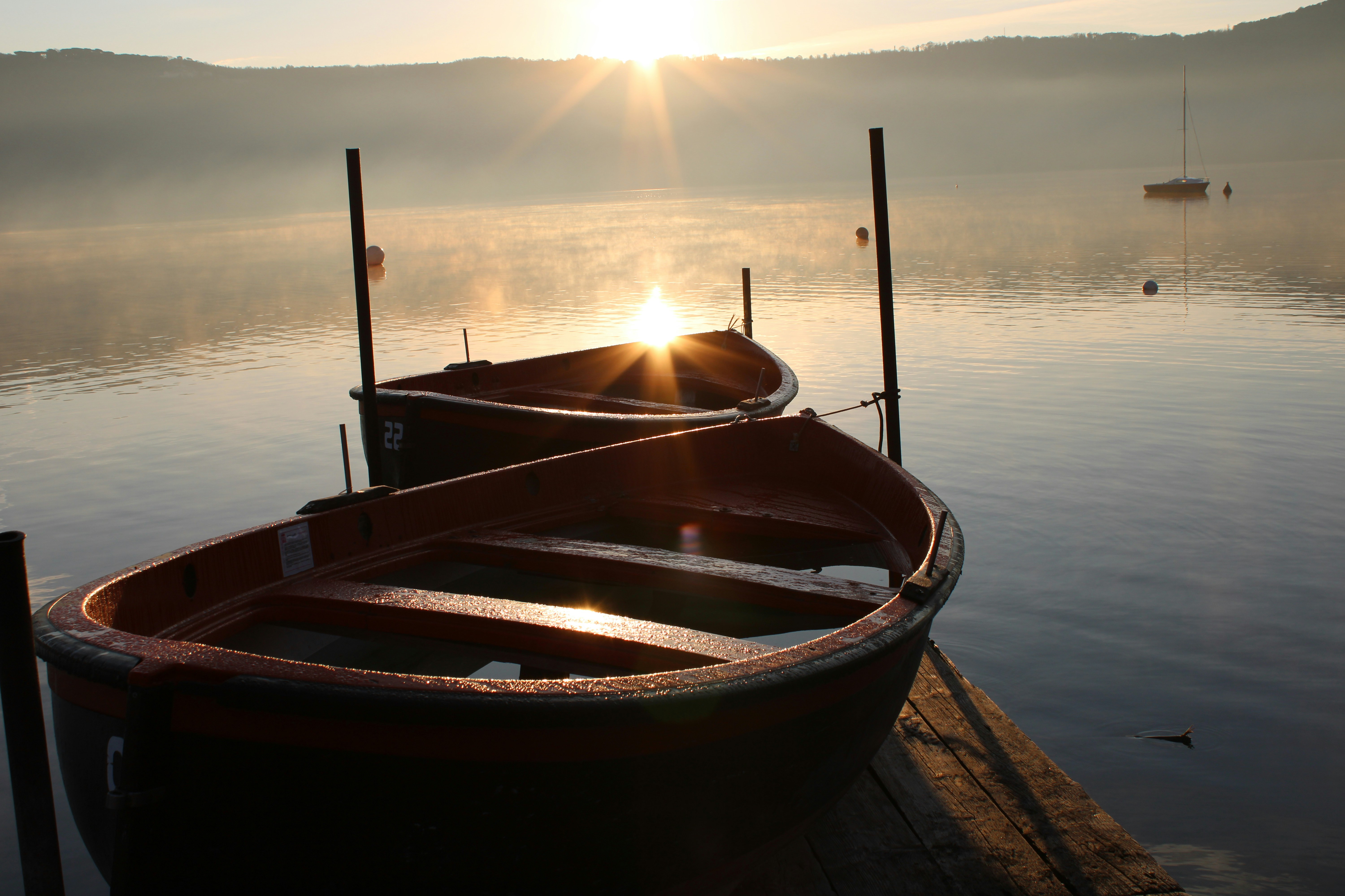 brown and white boat on dock during daytime