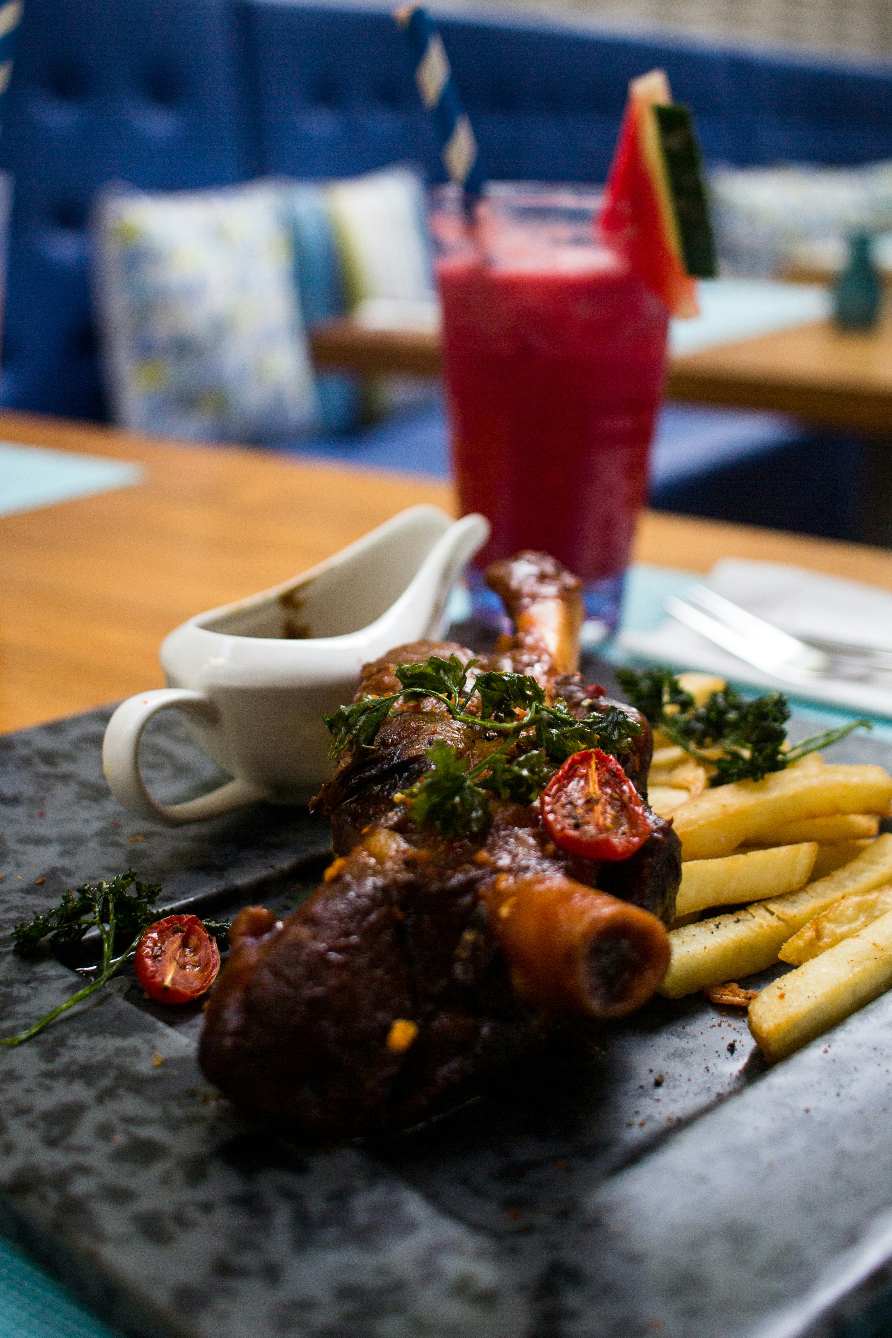 Charred Lamb Ribs and Golden Fries with a Crimson Cocktail at a Coastal Bistro