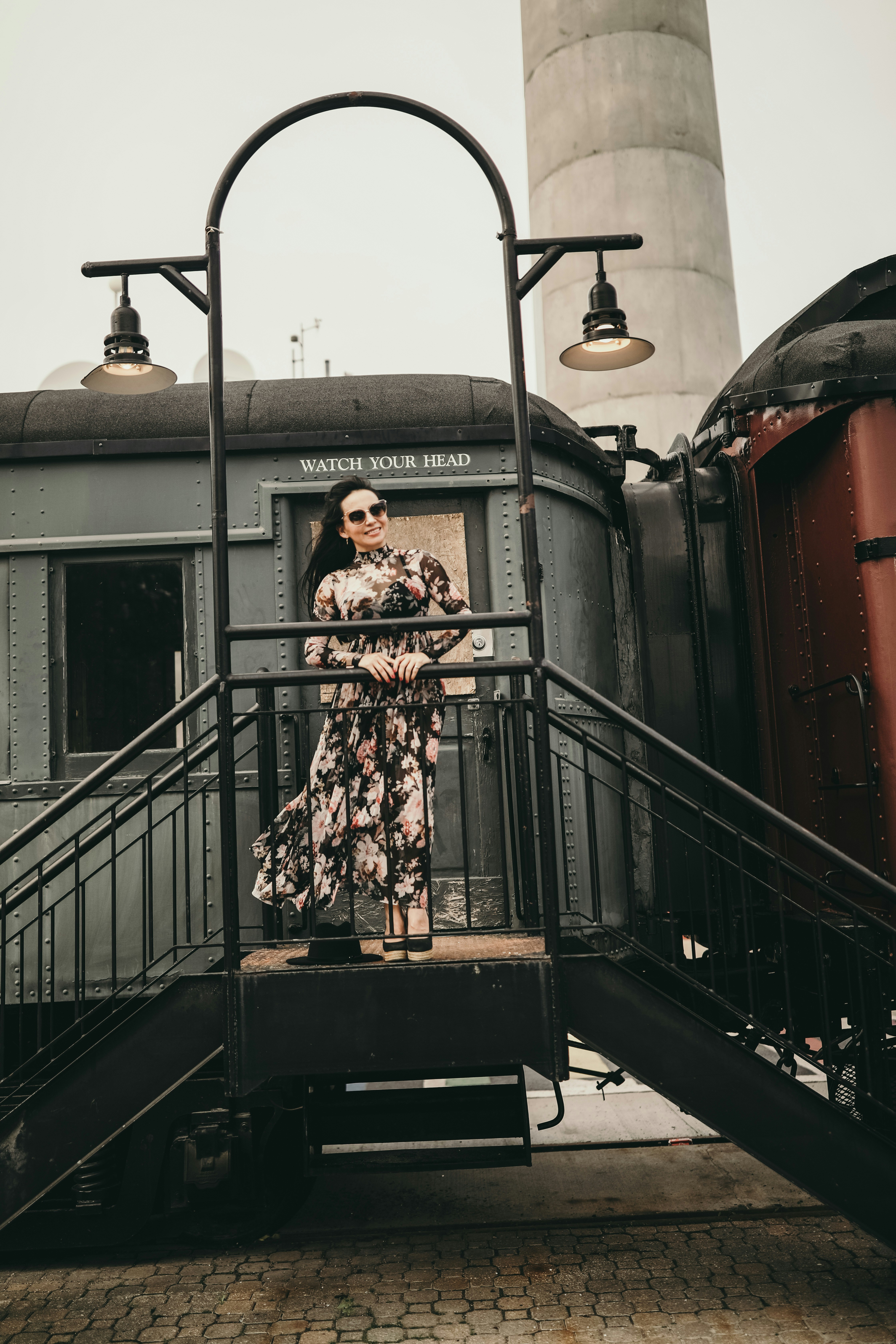 Floral silhouette on a moving platform under industrial arches