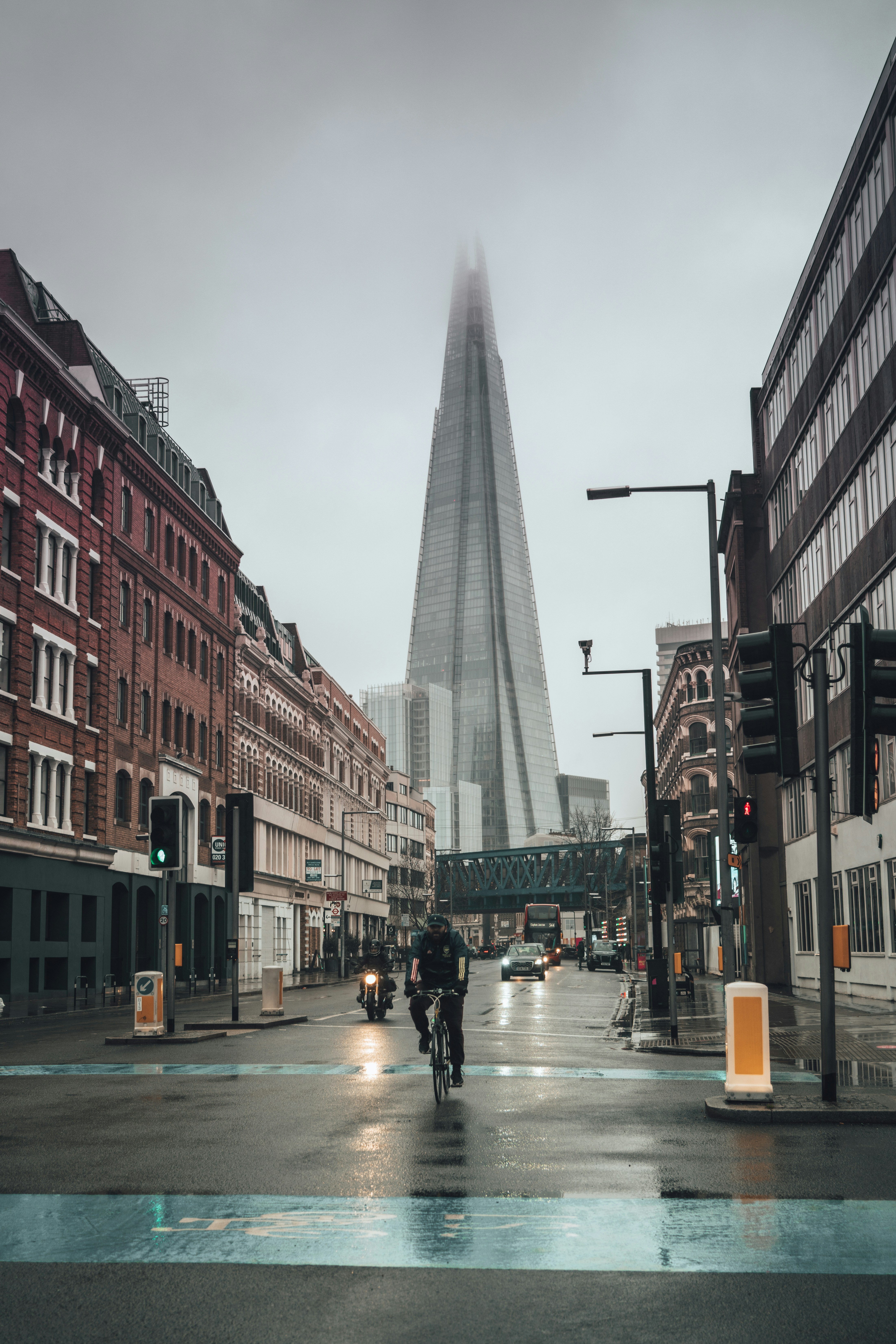 People walking on street between high rise buildings during daytime ...