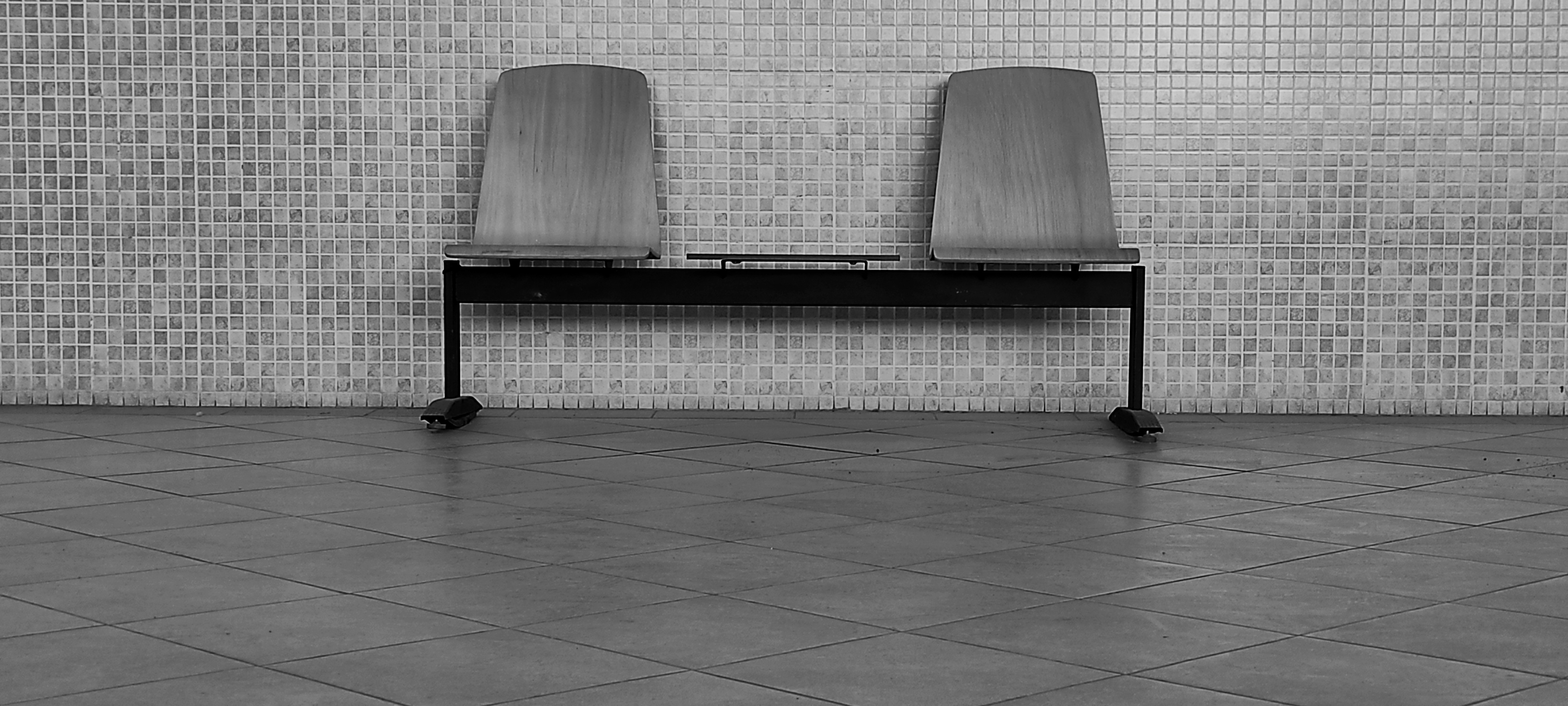 Minimalist Silence: A Lone Bench Anchored by Gridded Tiles