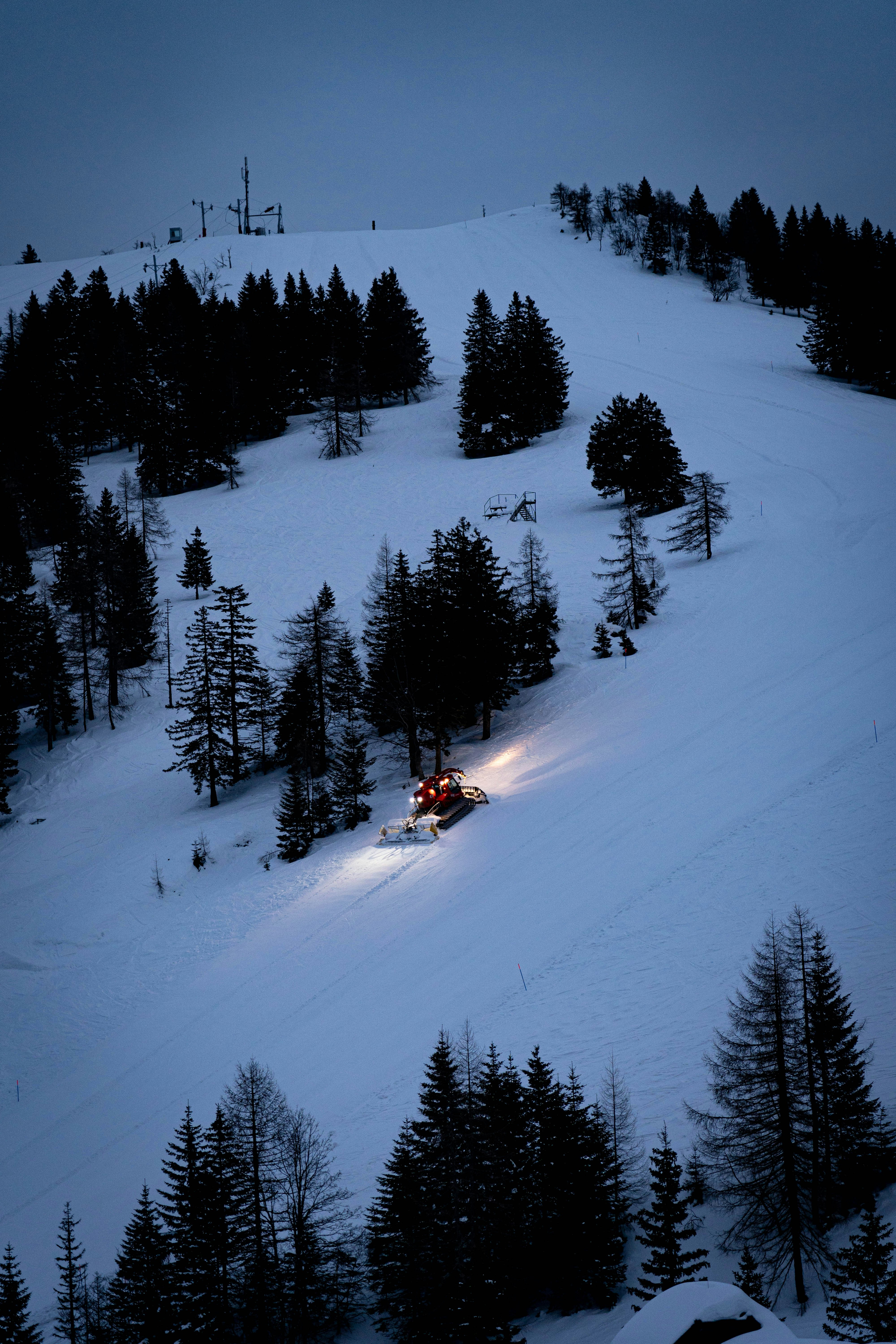 Neon Headlights Carve a Quiet Line Down the Alpine Slopes