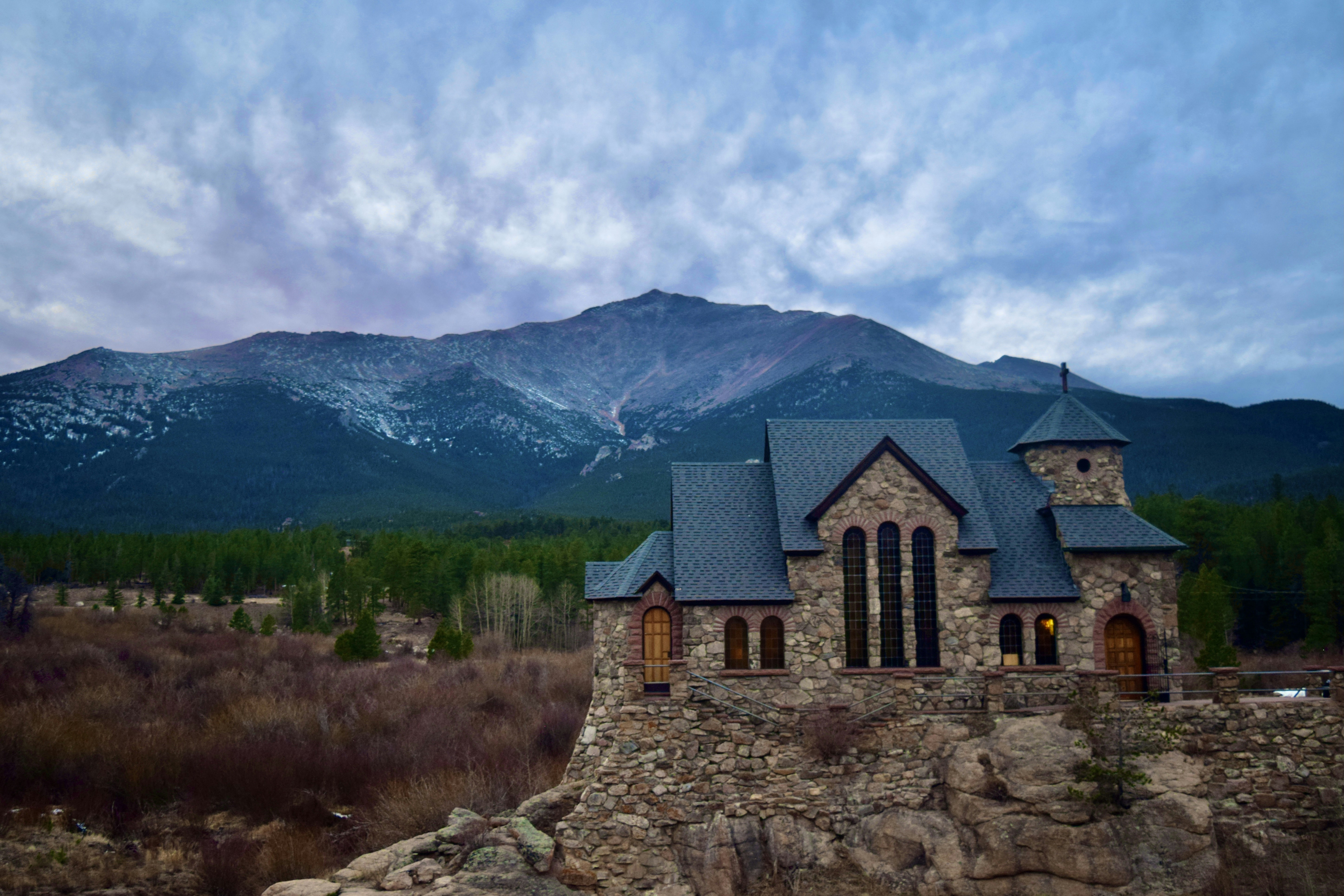 Rockbound Chapel on a Stone Promontory Under an Alpine Sky