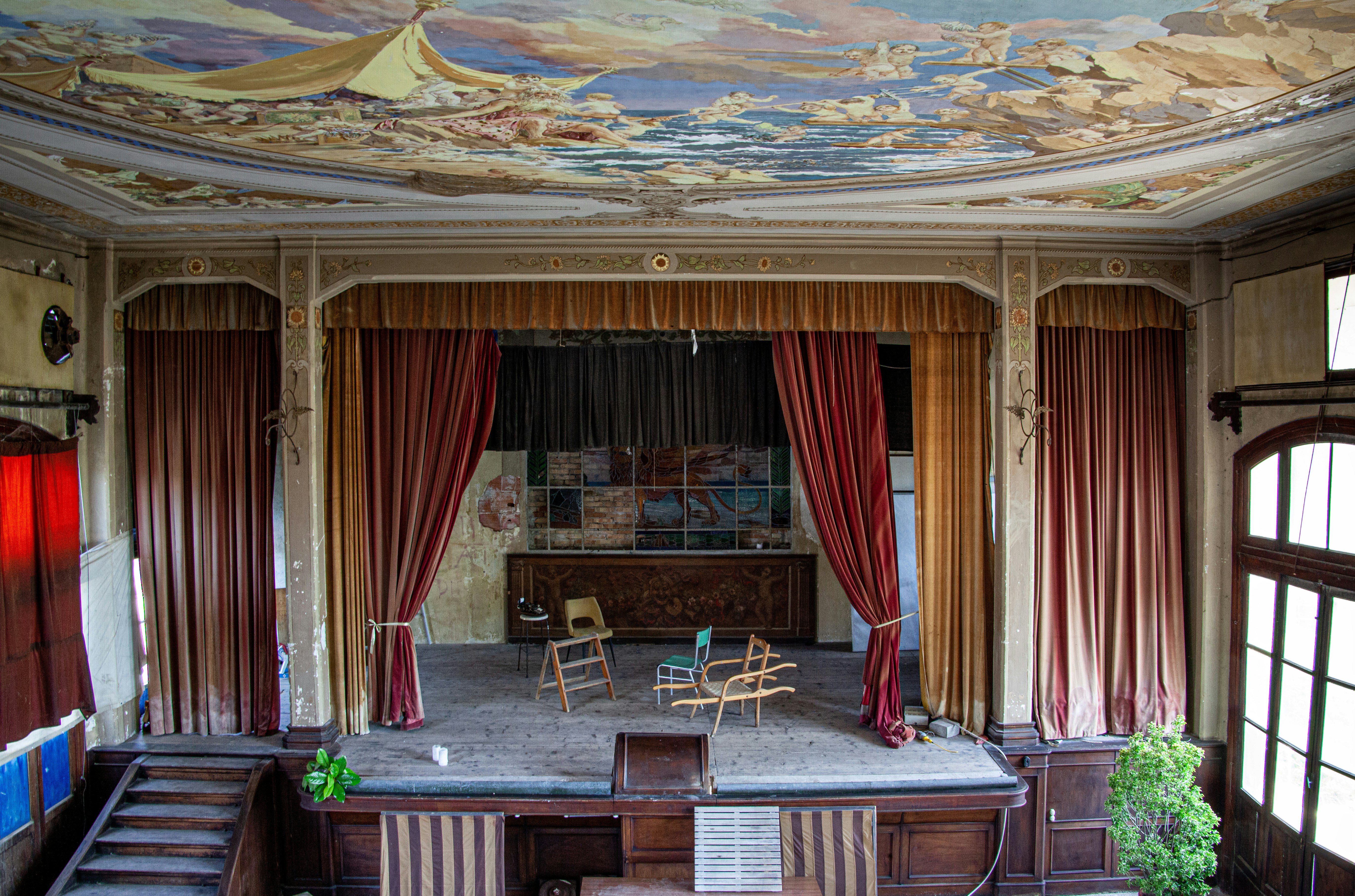 Vacant Velvet Stage Beneath a Painted Ceiling Mosaic