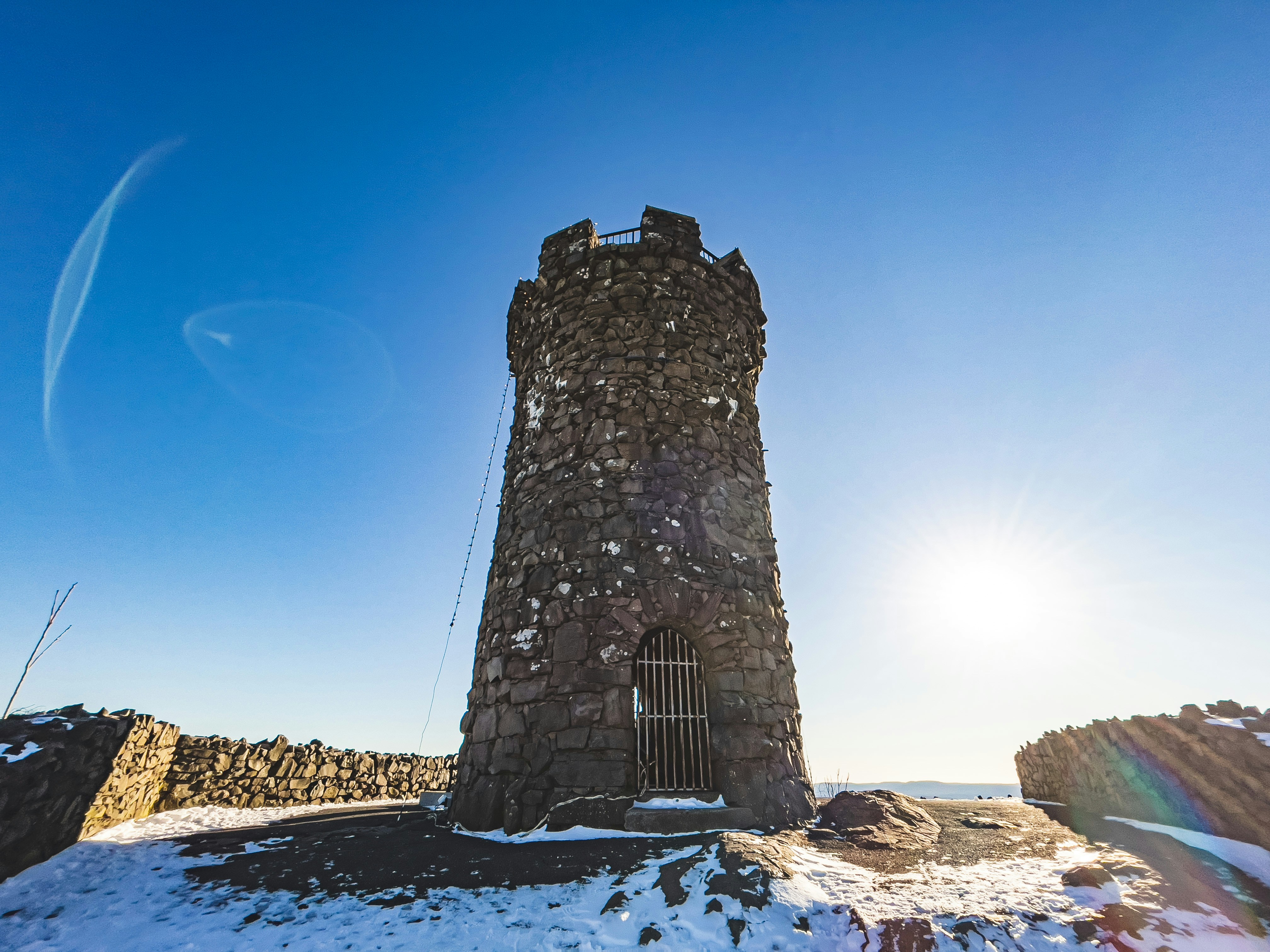 Stone Sentinel at Sea: Winter Sun over a Ruined Tower