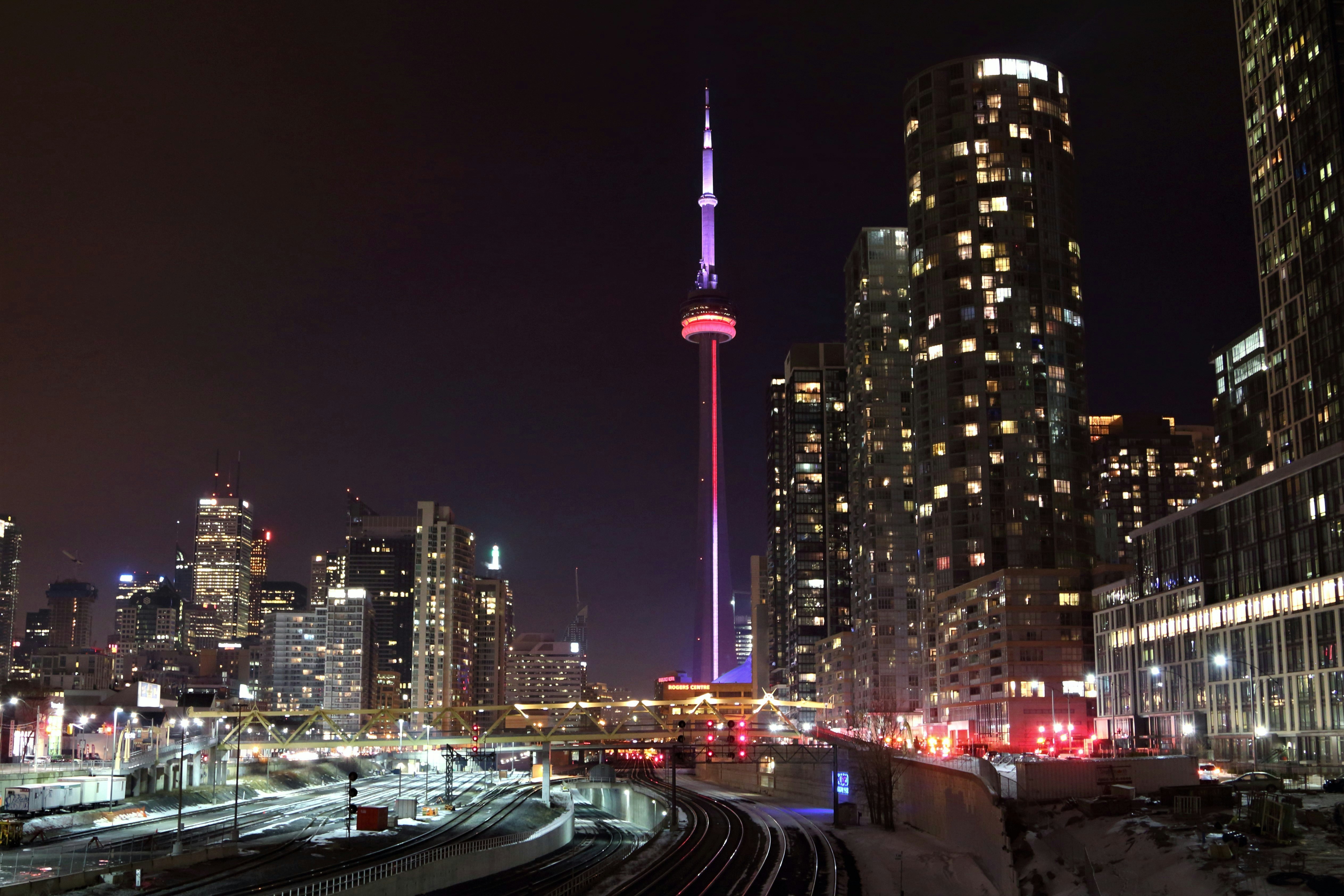 Purple Beacon Over a Snow-Dusted Toronto Skyline