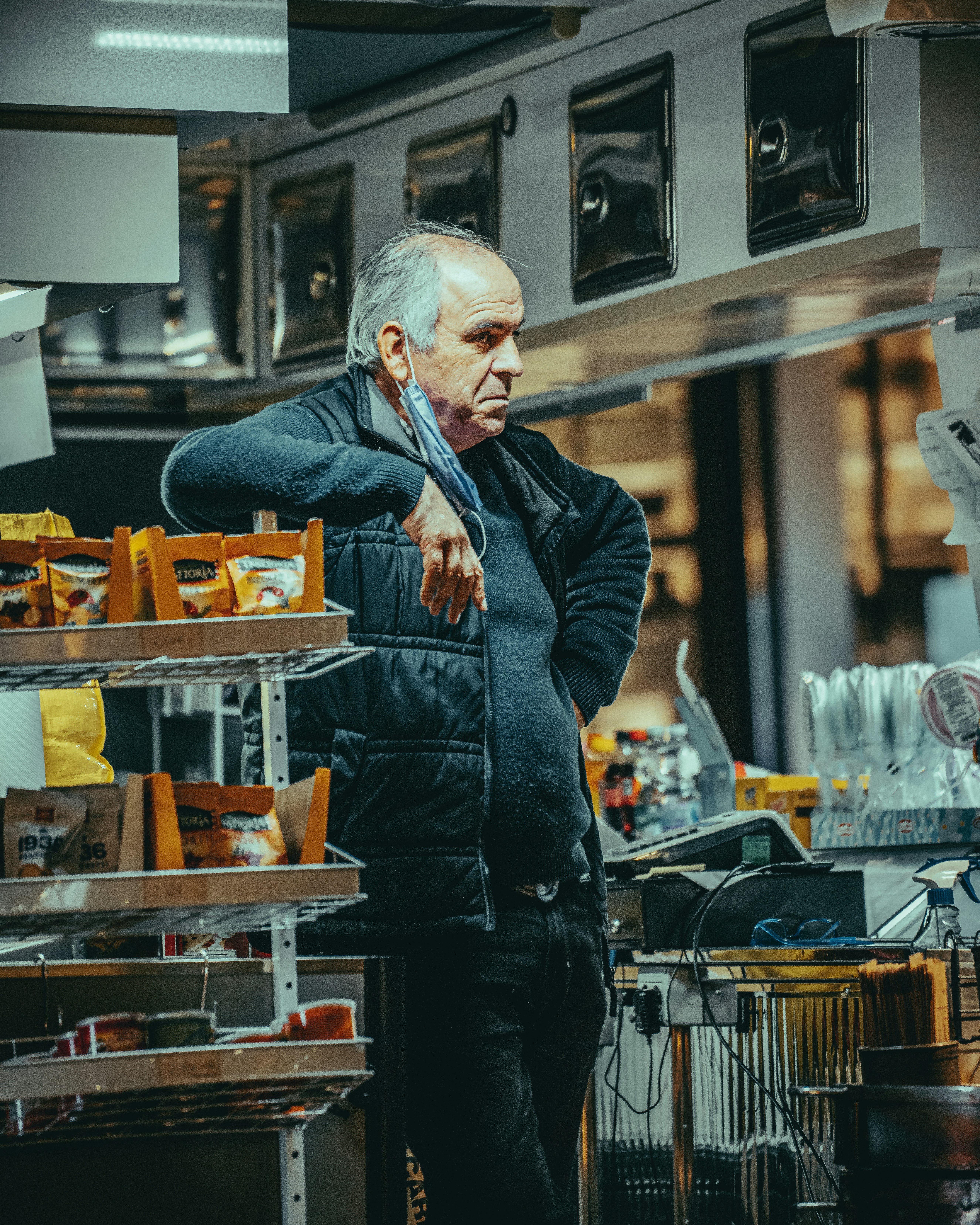 Contemplation at the Snack Shelf: A Quiet Storefront Moment