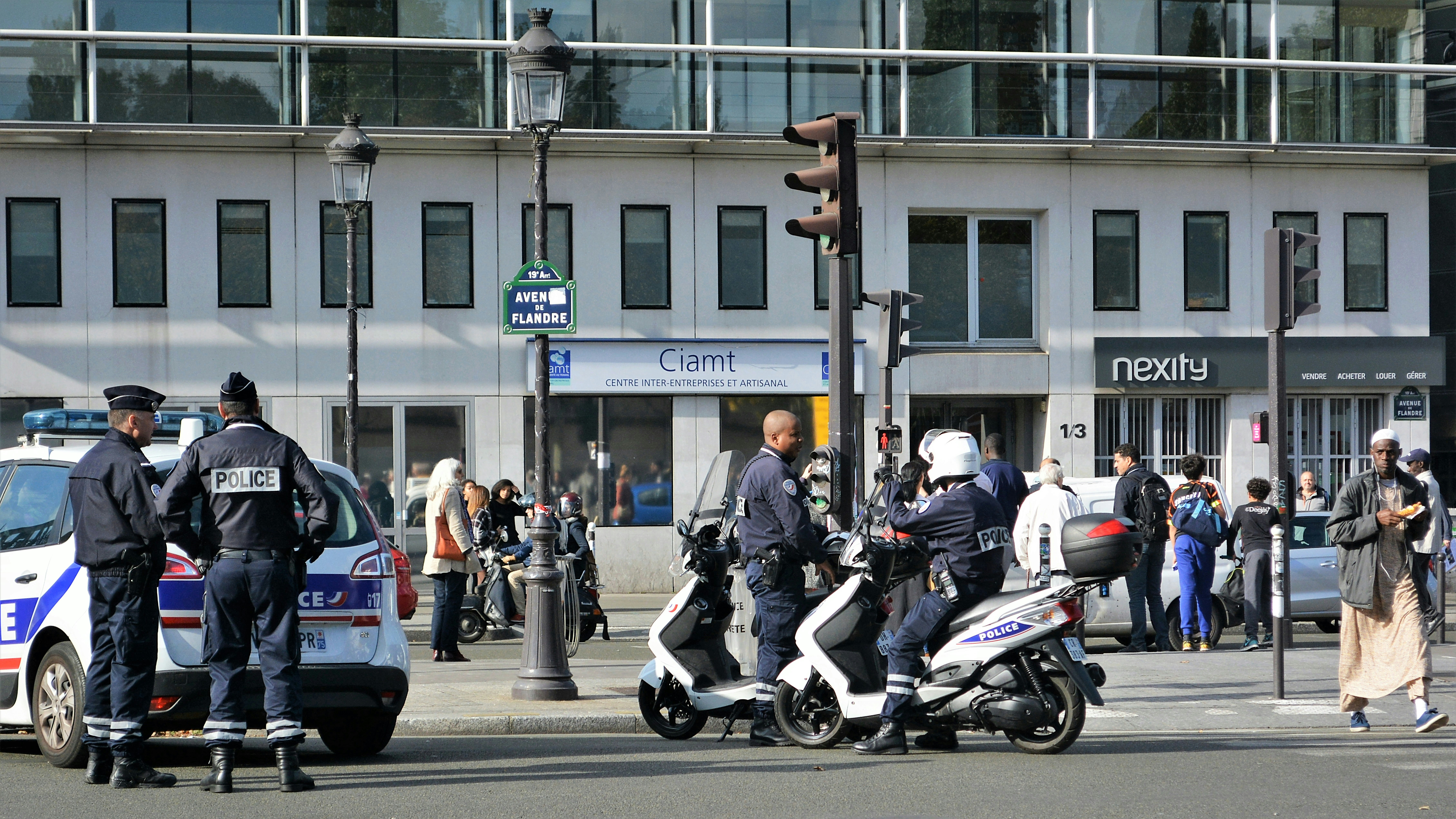 Police officers engage with the public at a busy intersection, showcasing urban safety and community interaction.