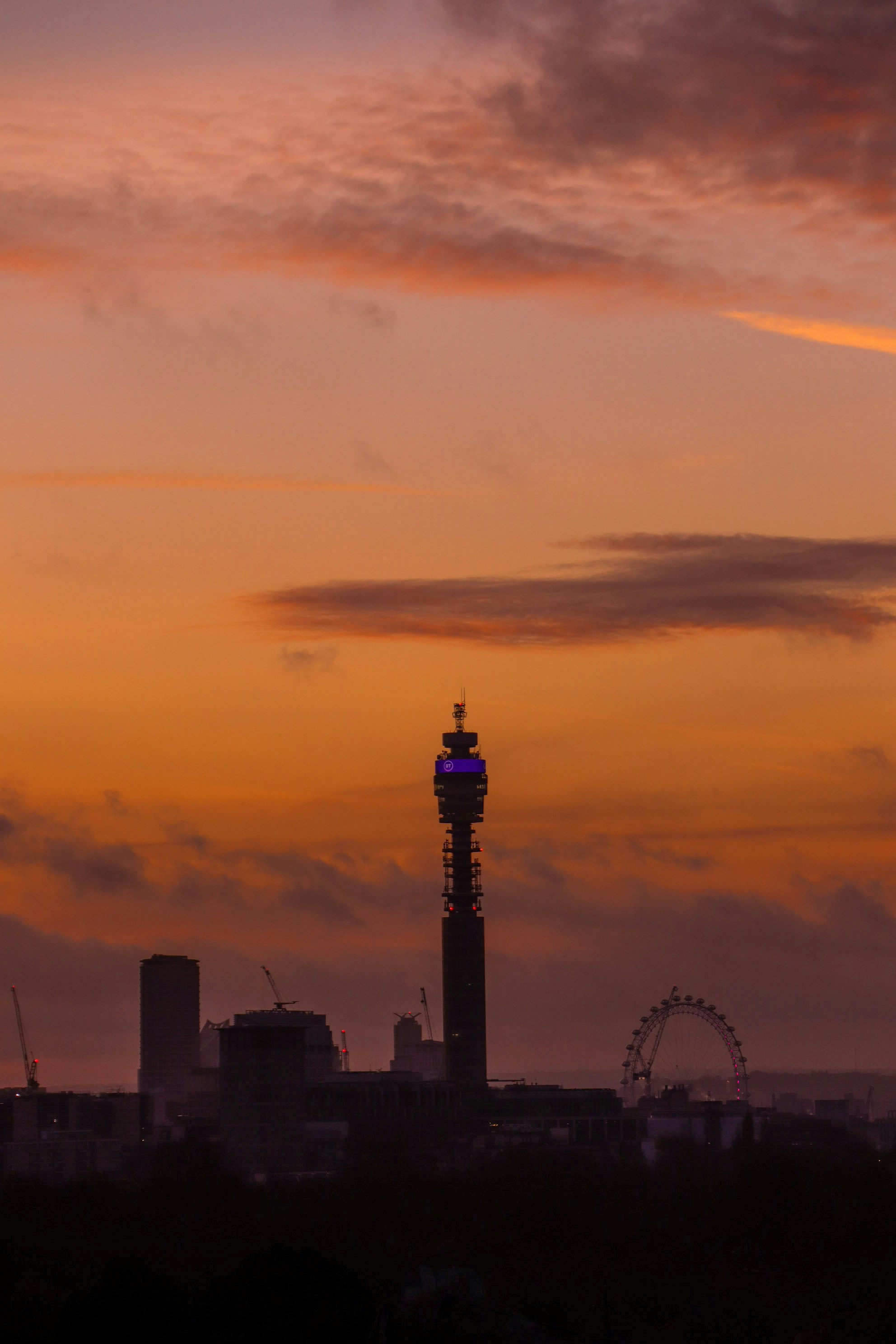 Purple Beacon Rises Over a Sunset London Skyline