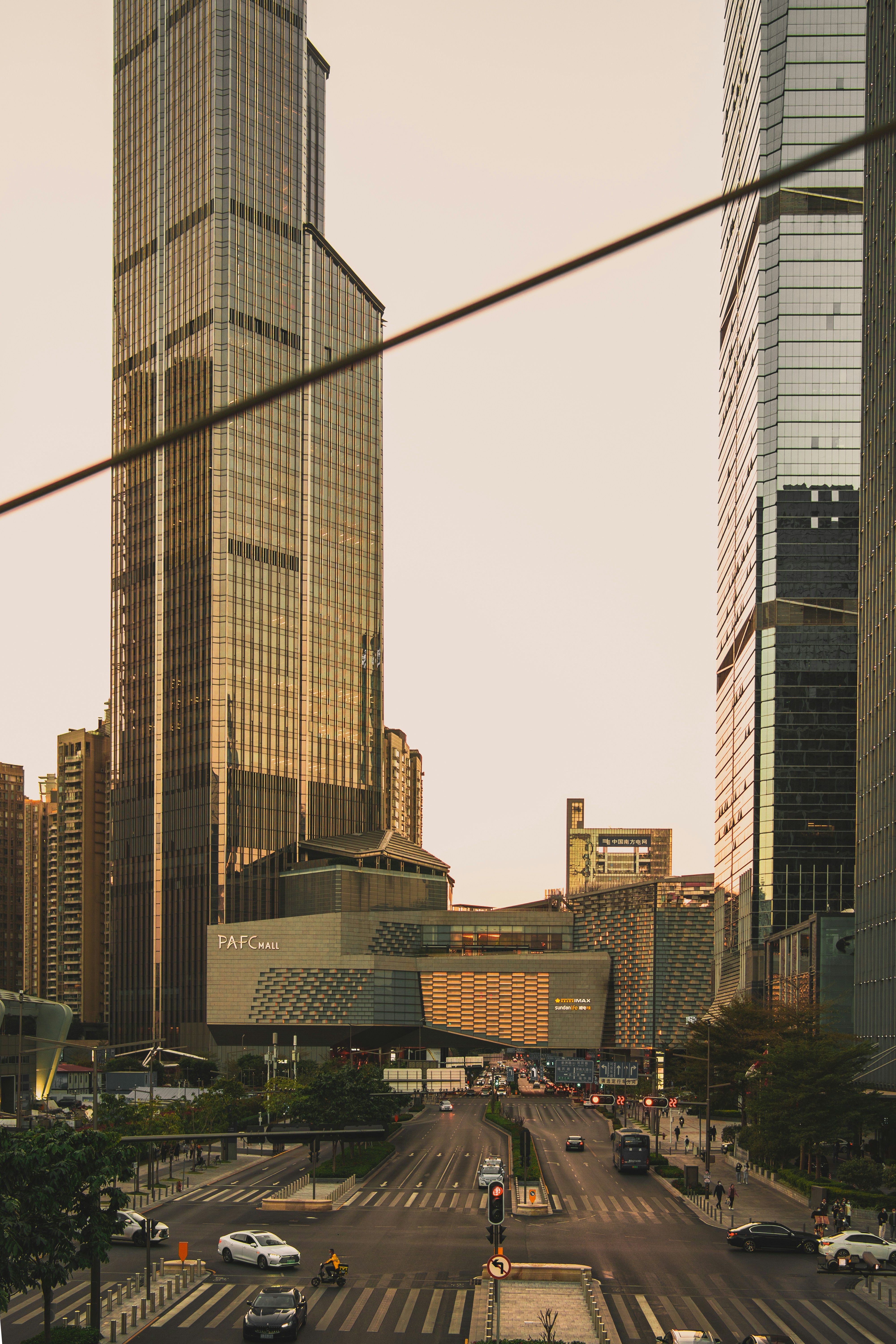 Cityscape featuring towering skyscrapers and bustling streets at dusk, highlighting the blend of contemporary design and urban life.
