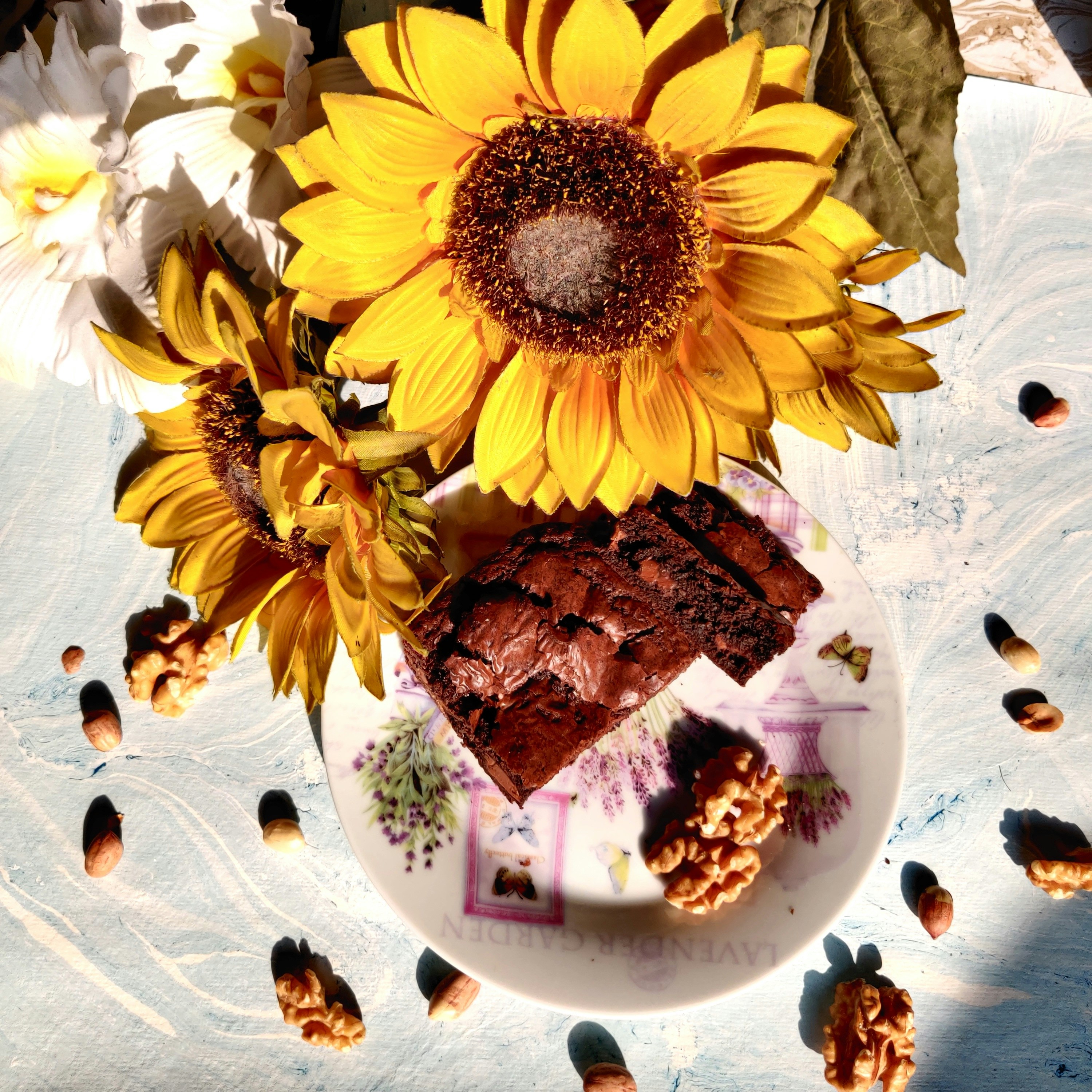 Sunlit Sunflowers and Chocolate Slice on a Weathered Table