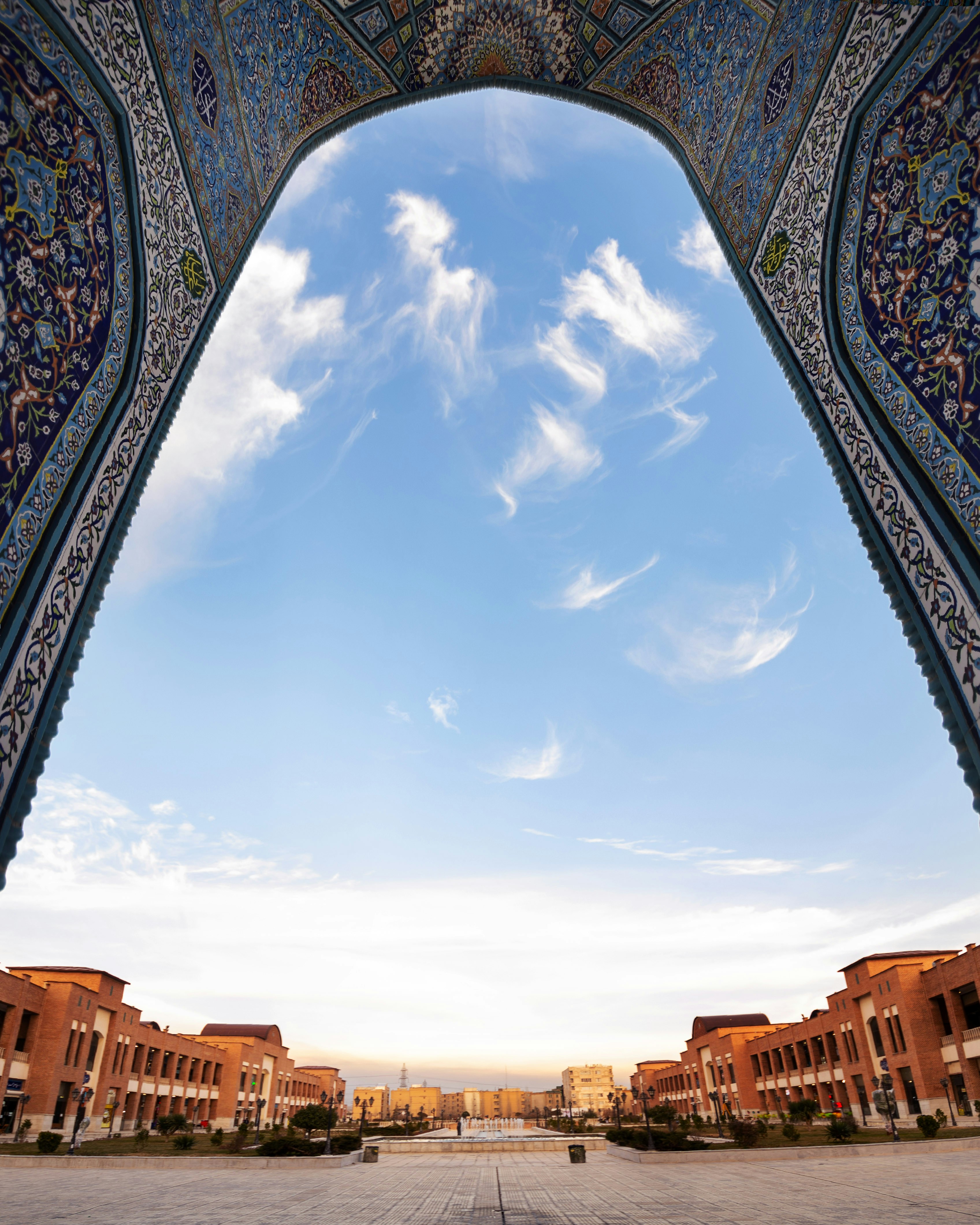 Open Sky Through a Mosaic Arch: Symmetry Over a Sunlit Plaza