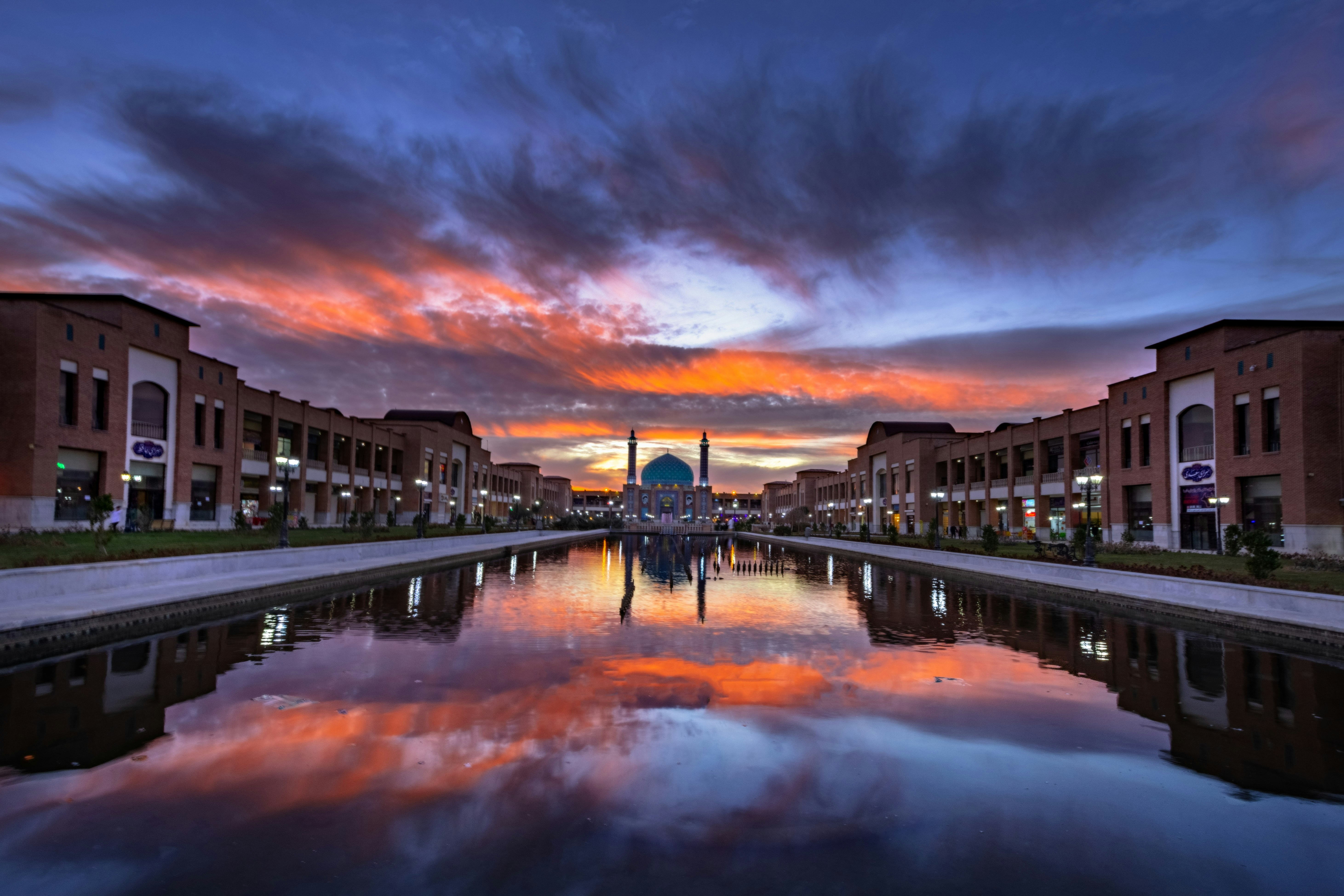 Dusk Convergence: The Dome-Bound Canal Framed by Brick Arcades