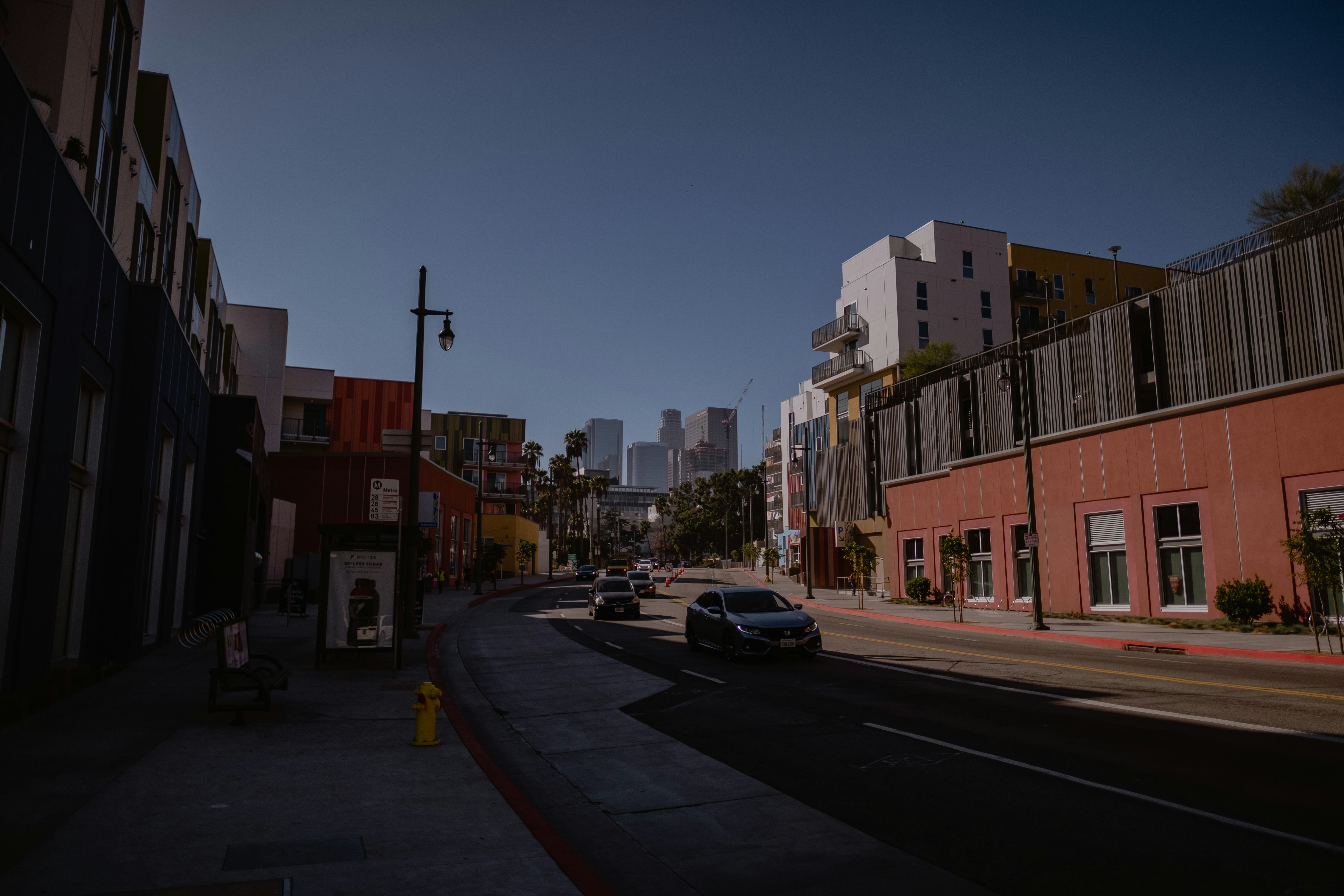 Sunlit Boulevard Toward a Distant Skyline