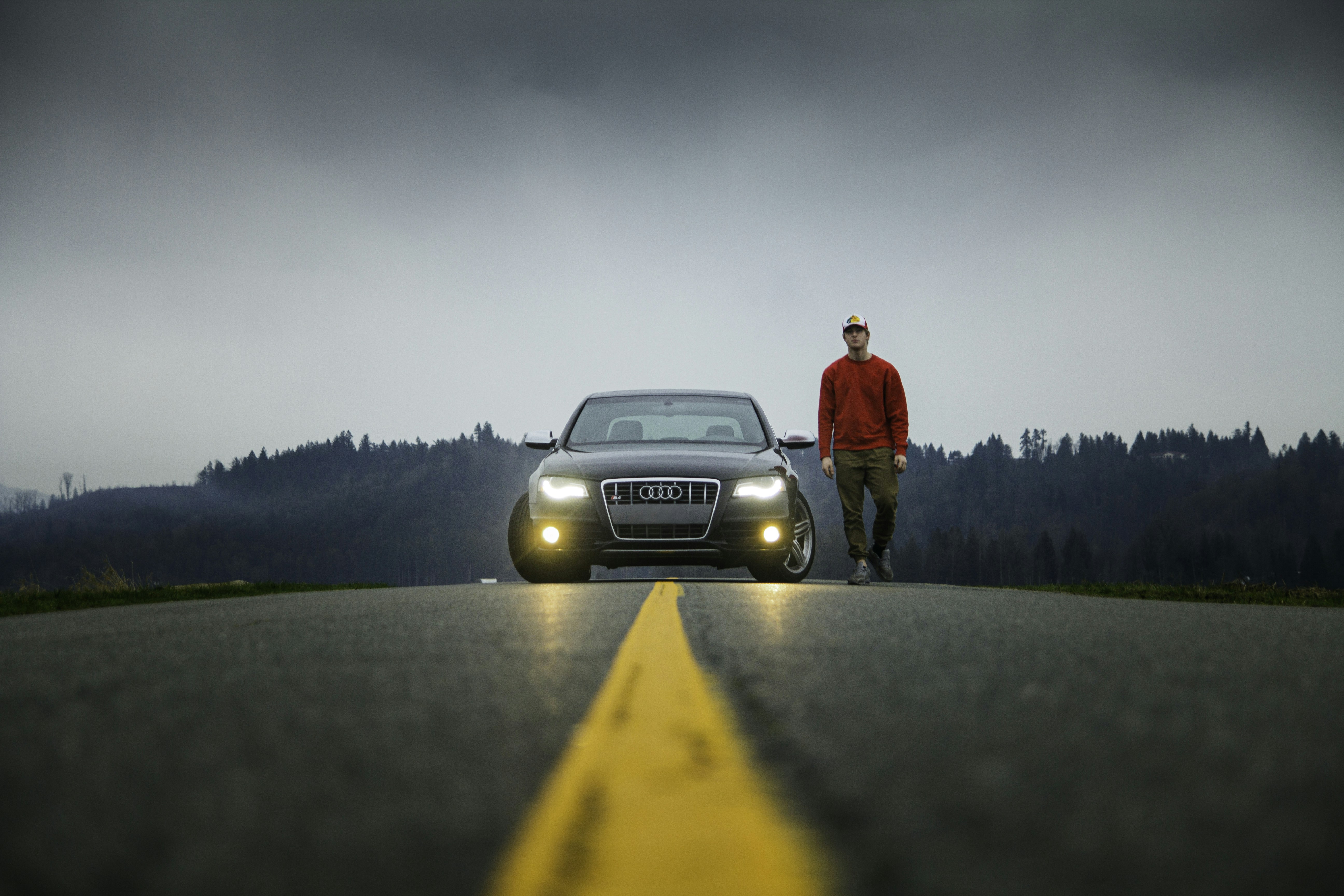 Headlights on the Horizon: An Audi and a Pedestrian on a Quiet, Overcast Highway