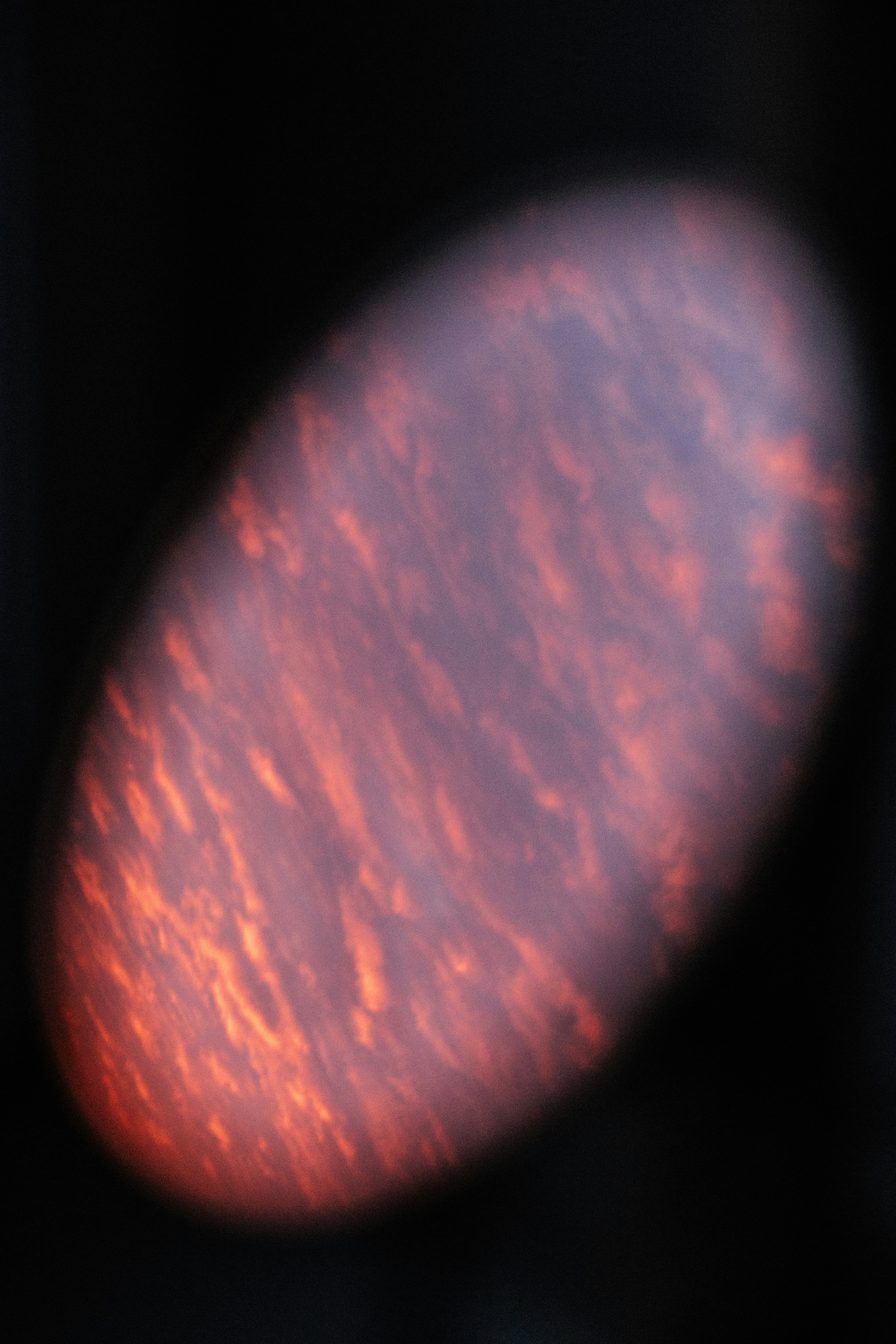 Ember Ellipse: Veined Glow in a Dark Field