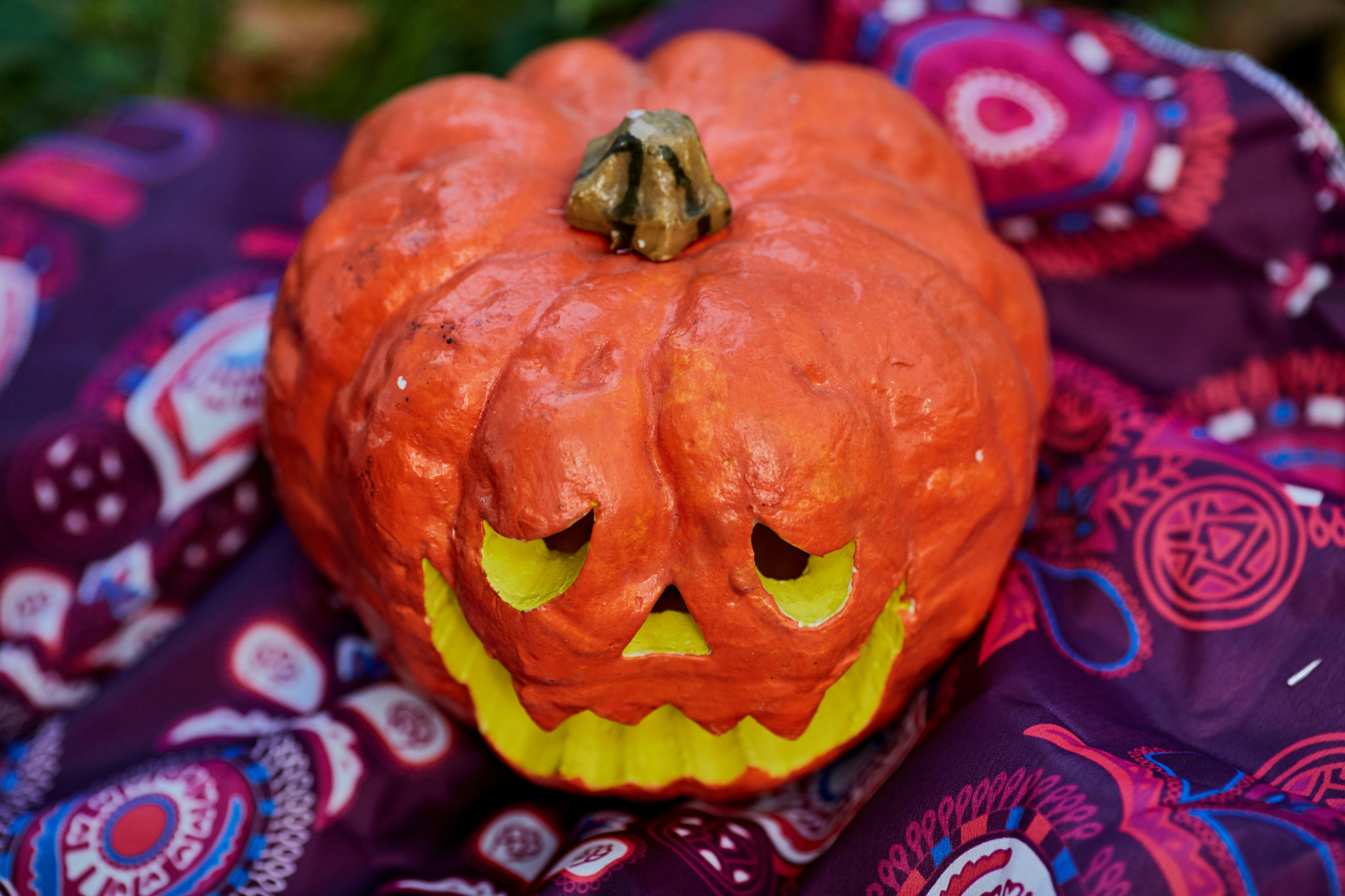 Glowing Jack-O'-Lantern on a Rich Paisley Fabric