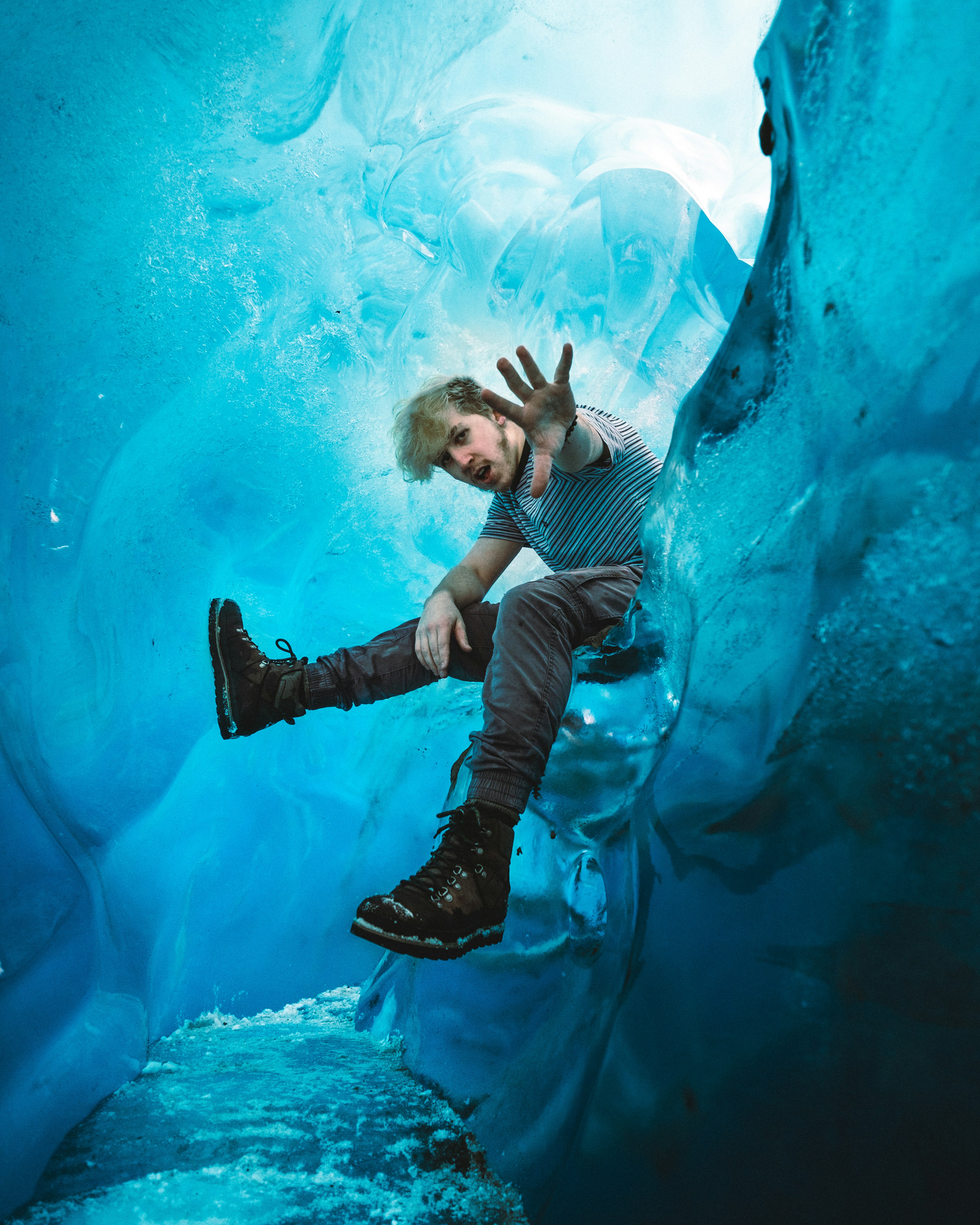 Outstretched in the Blue Abyss: A Moment Inside a Glacier Ice Cathedral