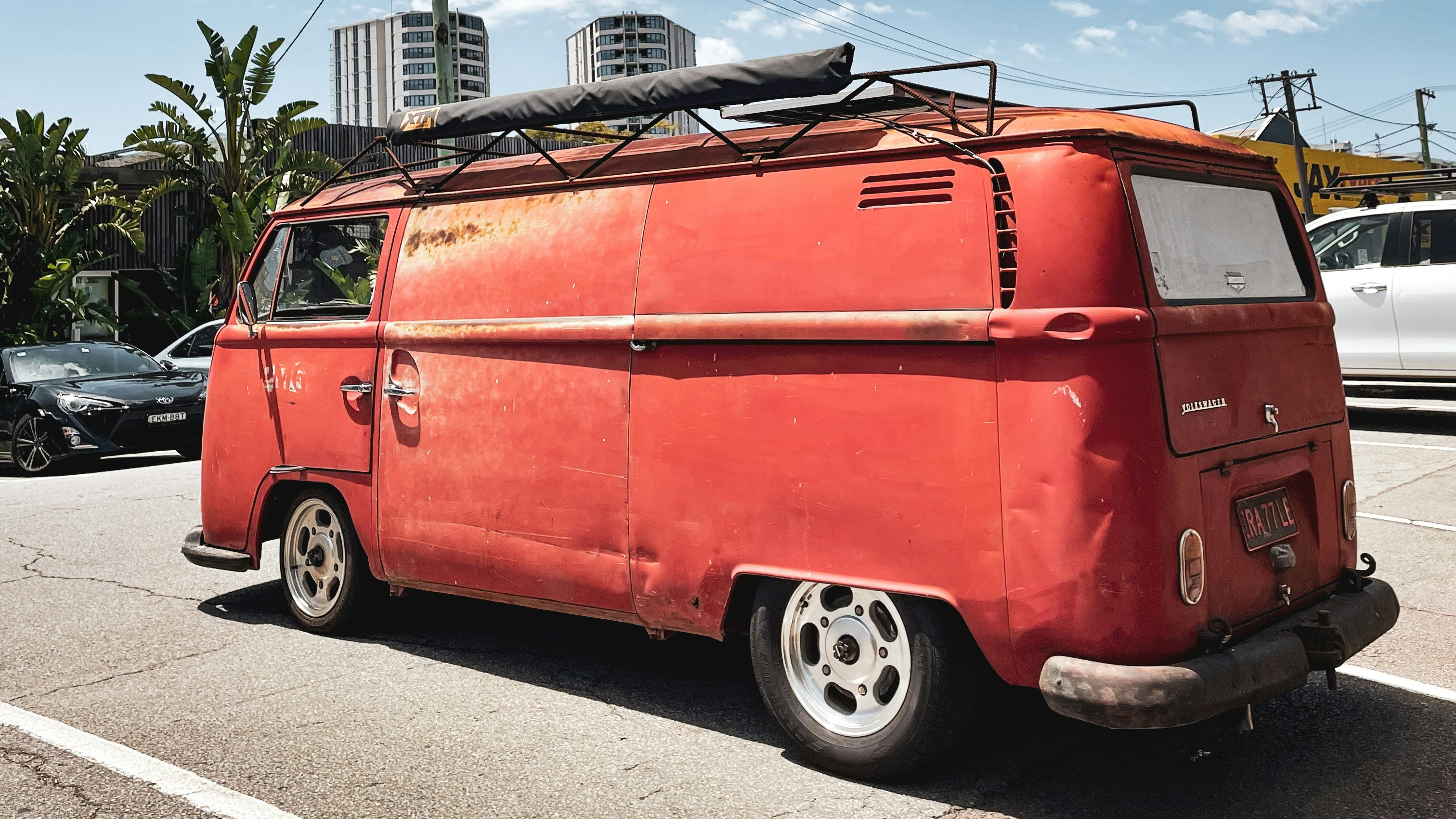 Sunburnt Velvet: A Red Vintage Van in a Parking Lot