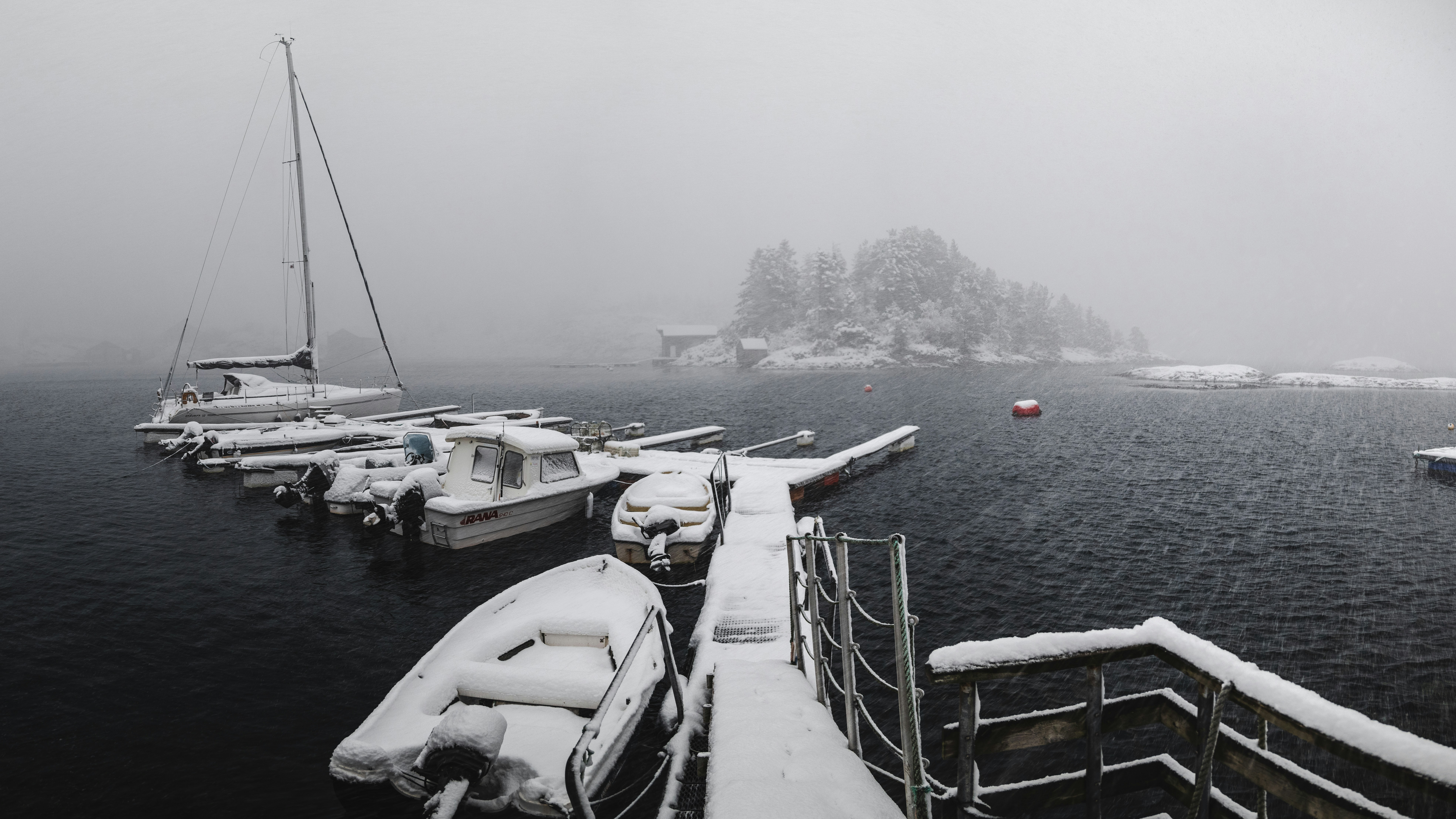 Snowbound Marina: Boats at Rest in a Quiet, Fog-Wrapped Harbor