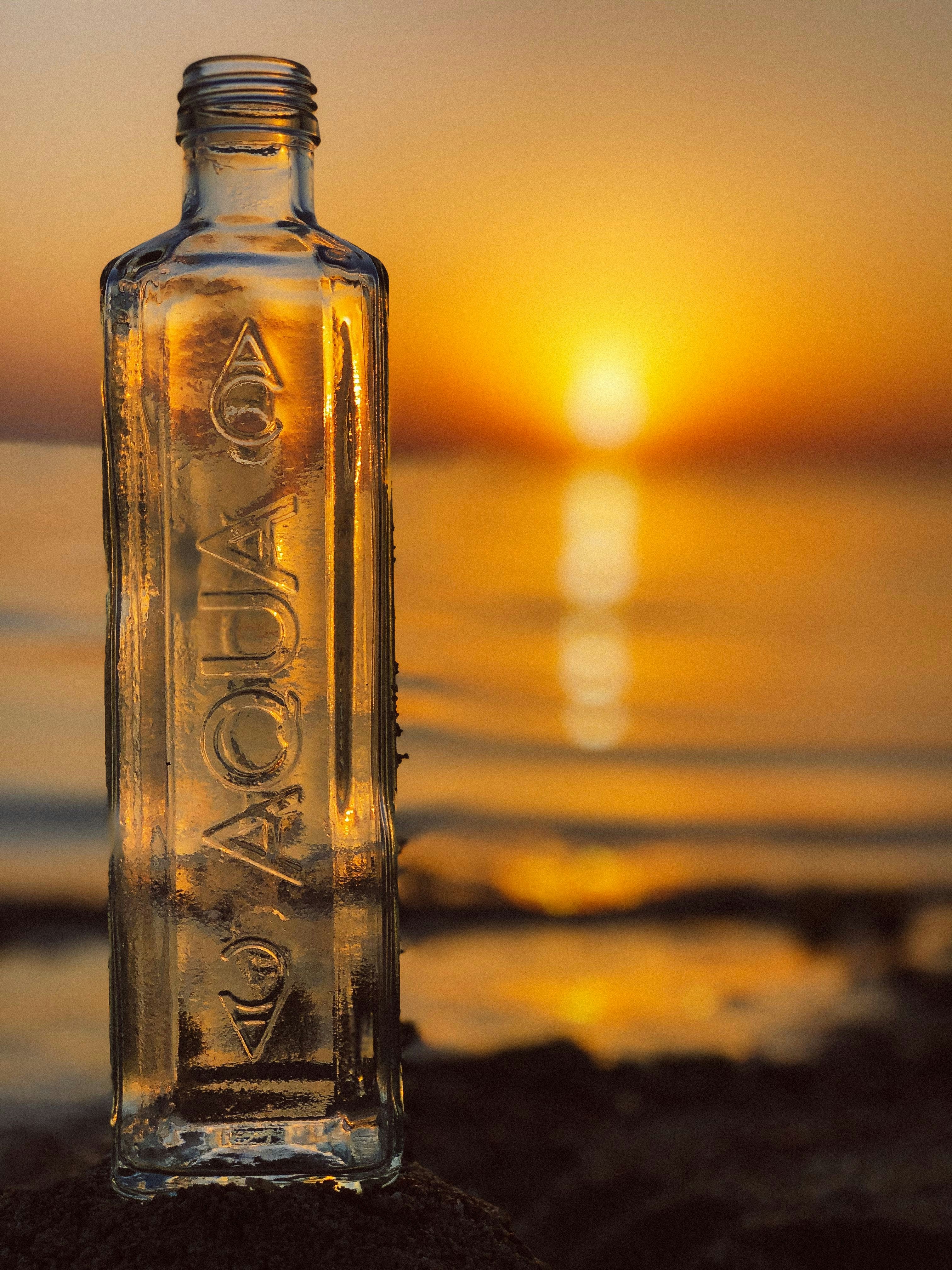 selective focus photography of glass bottle