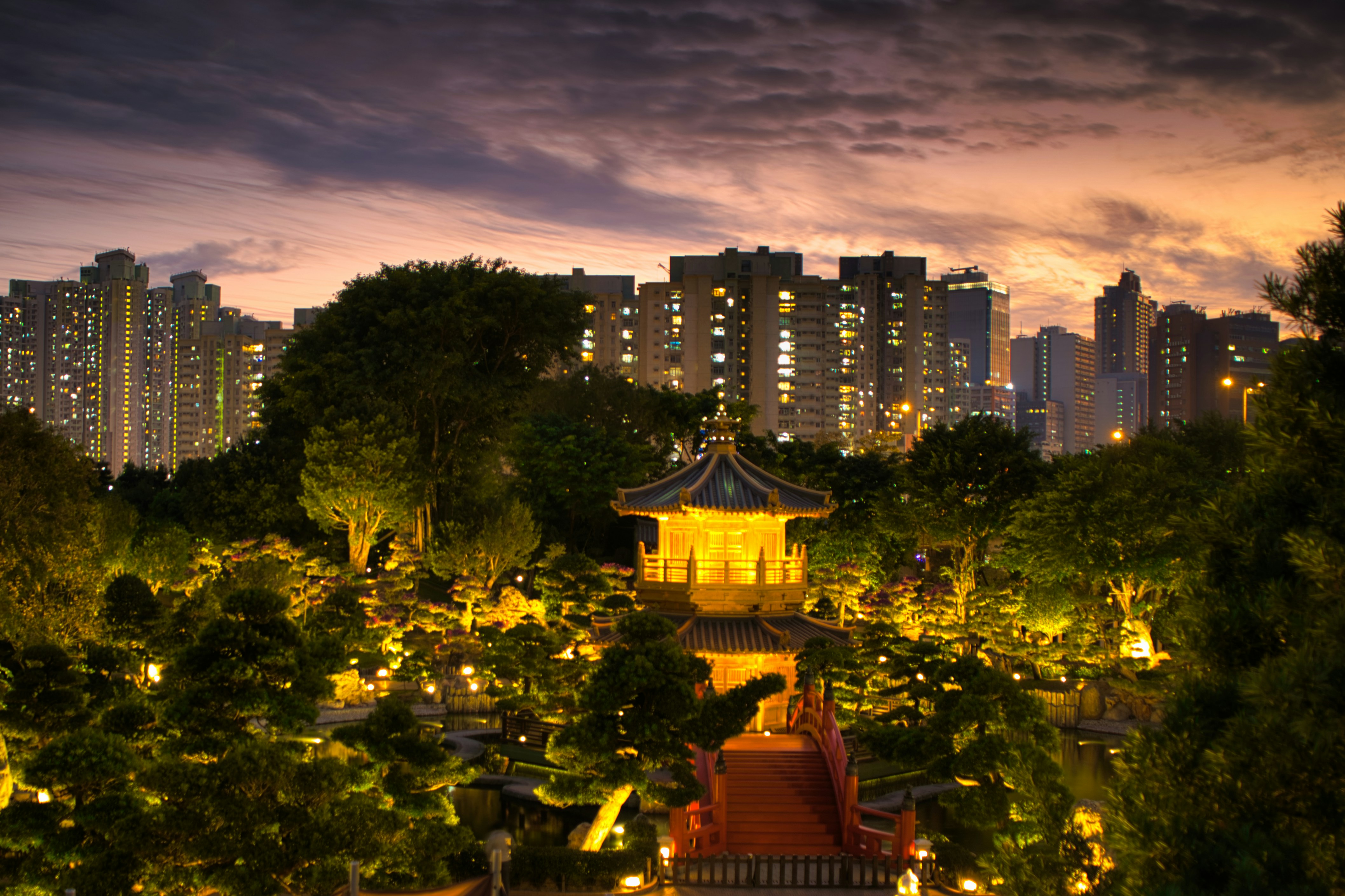 Green trees near brown building during night time photo – Free Temple ...