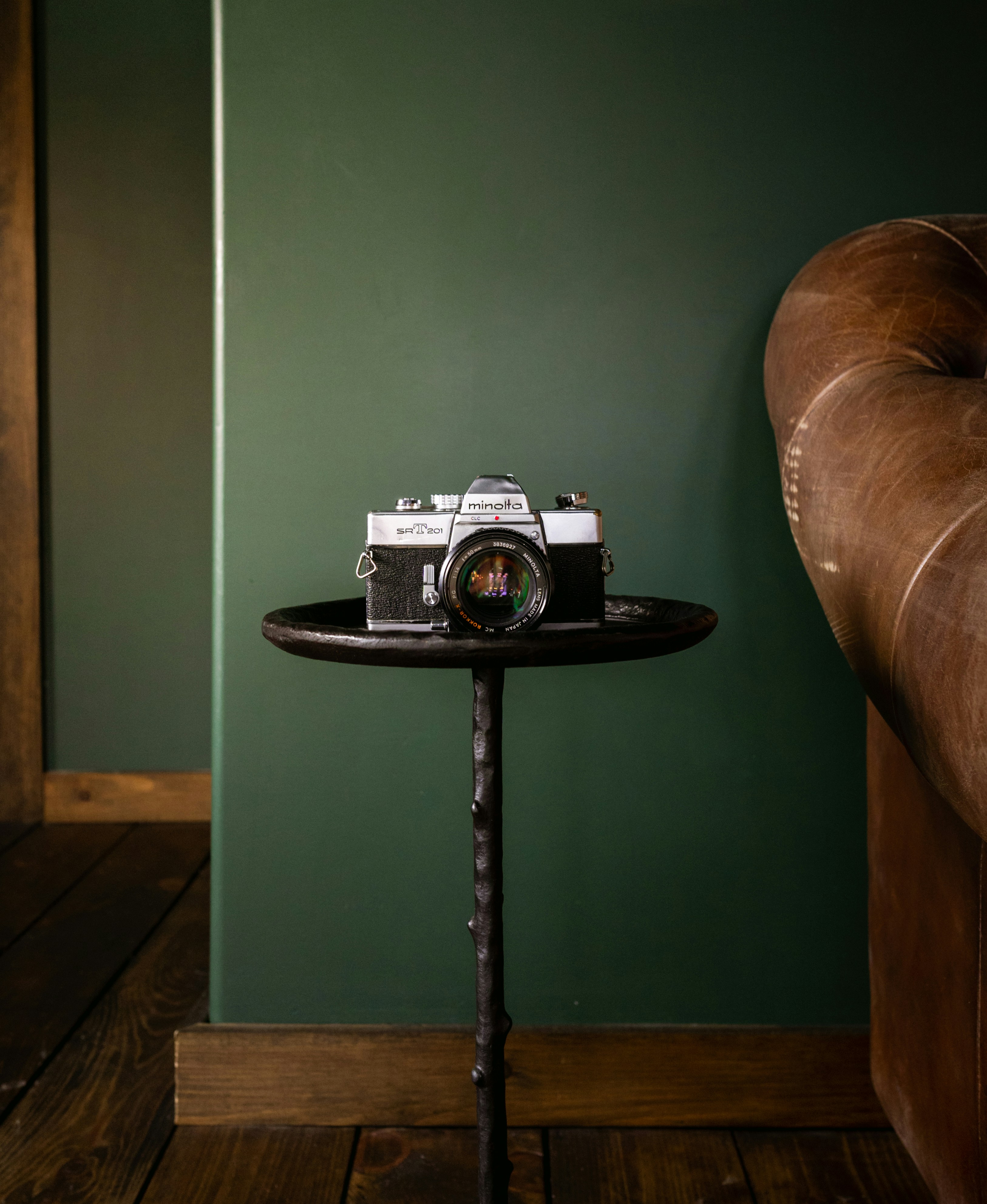 Silent Sentinel: A Vintage Minolta on a Petite Table in a Green Room