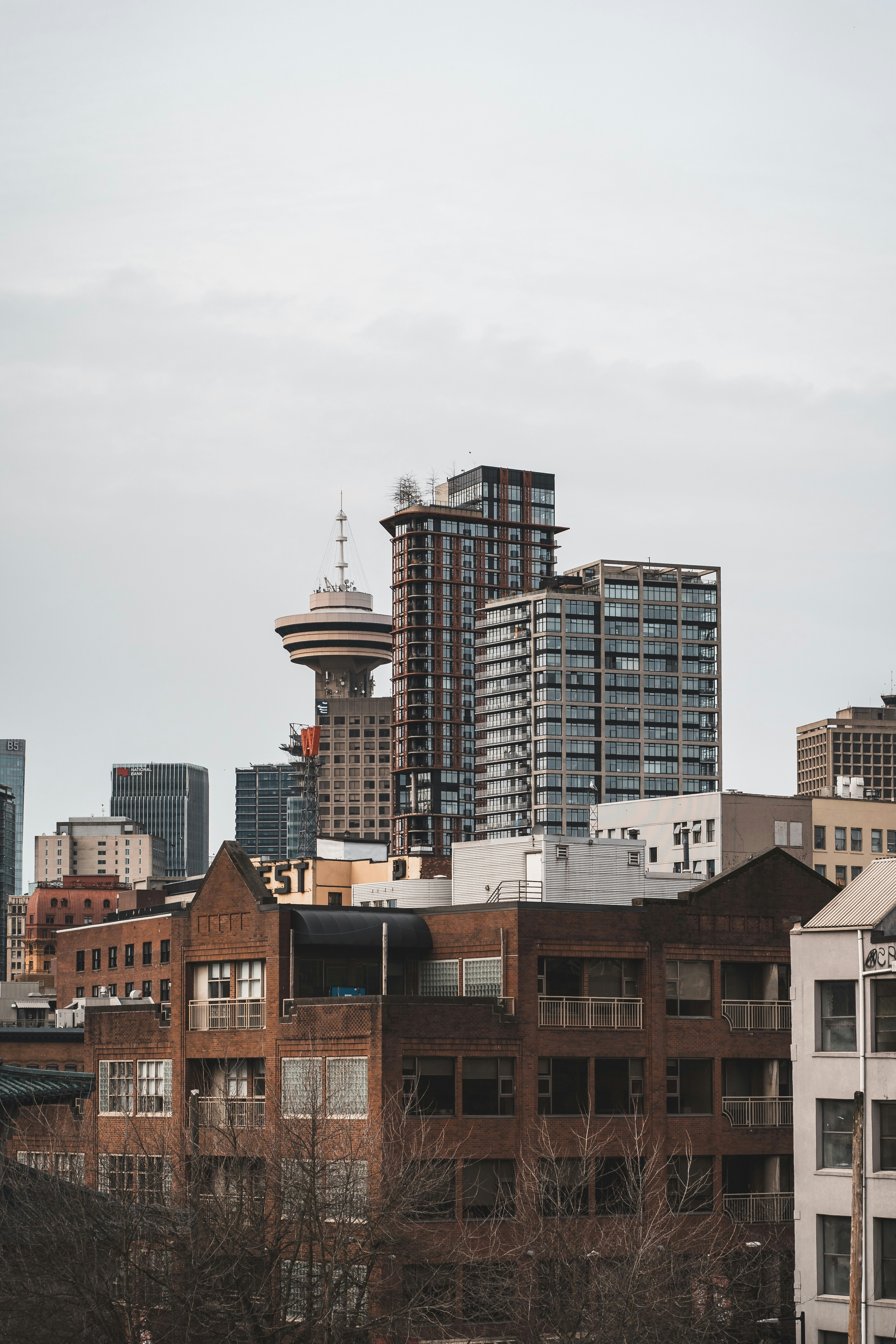 City Silhouette: Towers Rising Over Brick Industrial Facades