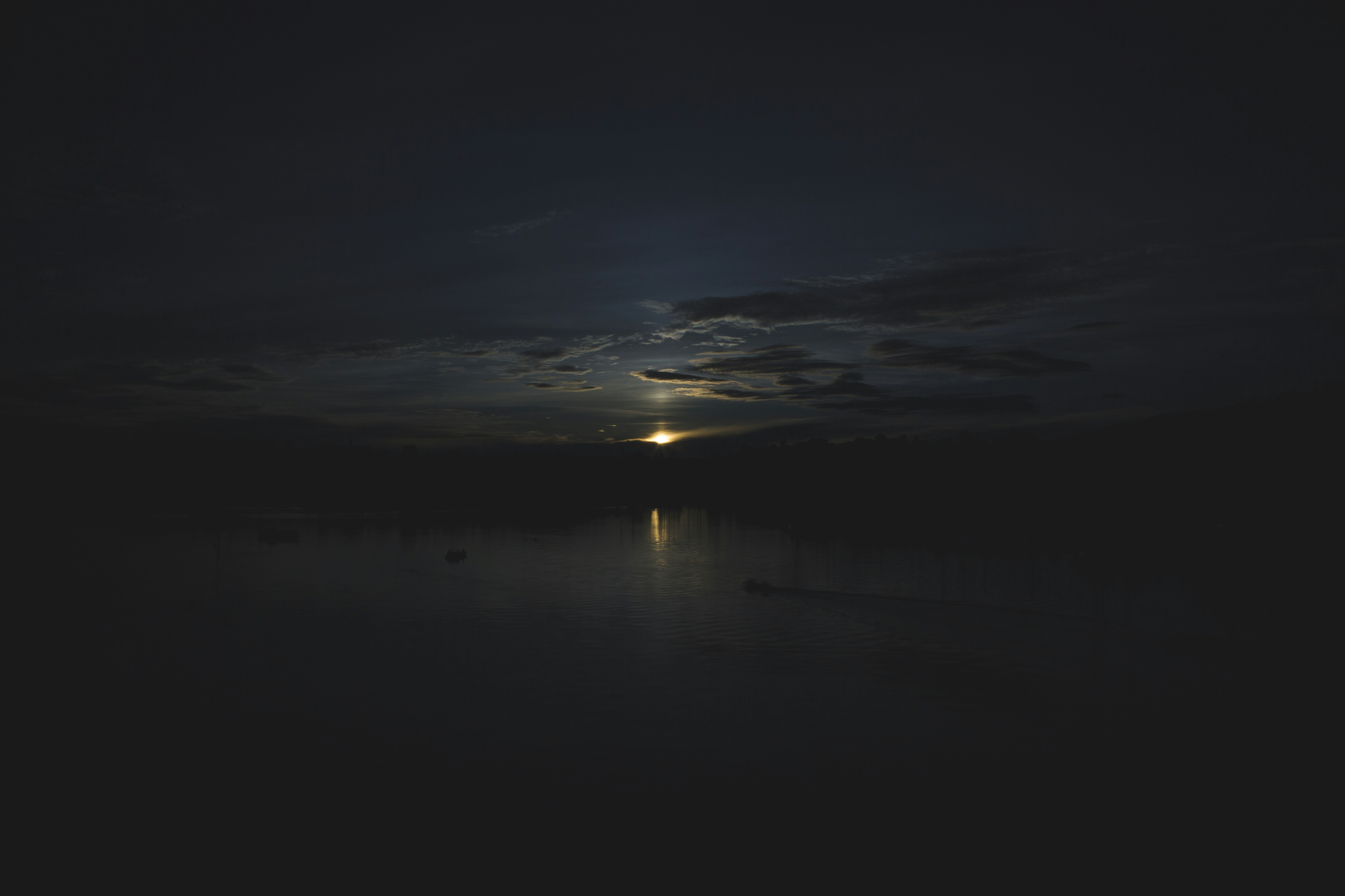 Dawn's Quiet Edge: A Silenced Horizon Over Still Water