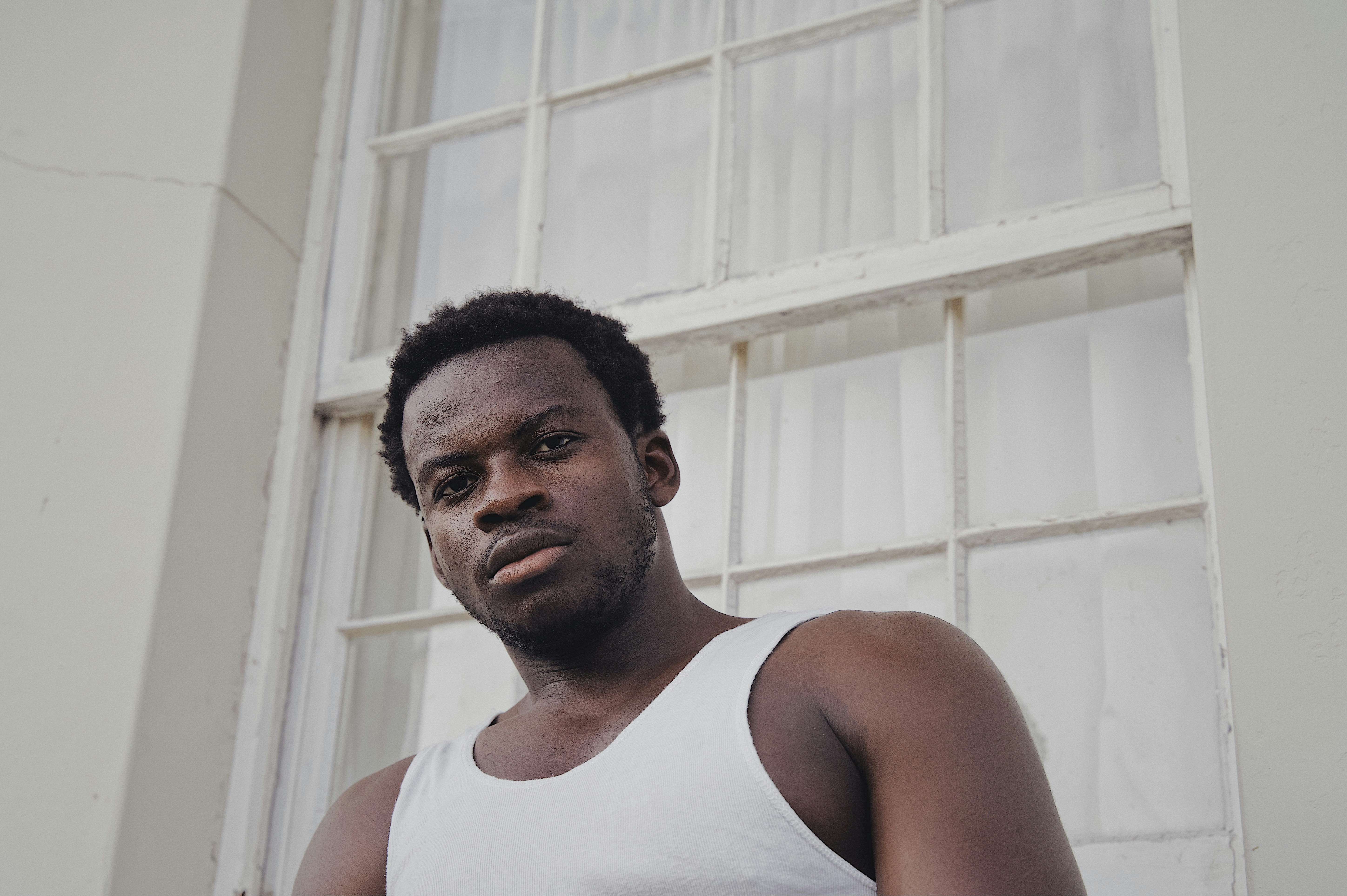 man in white tank top