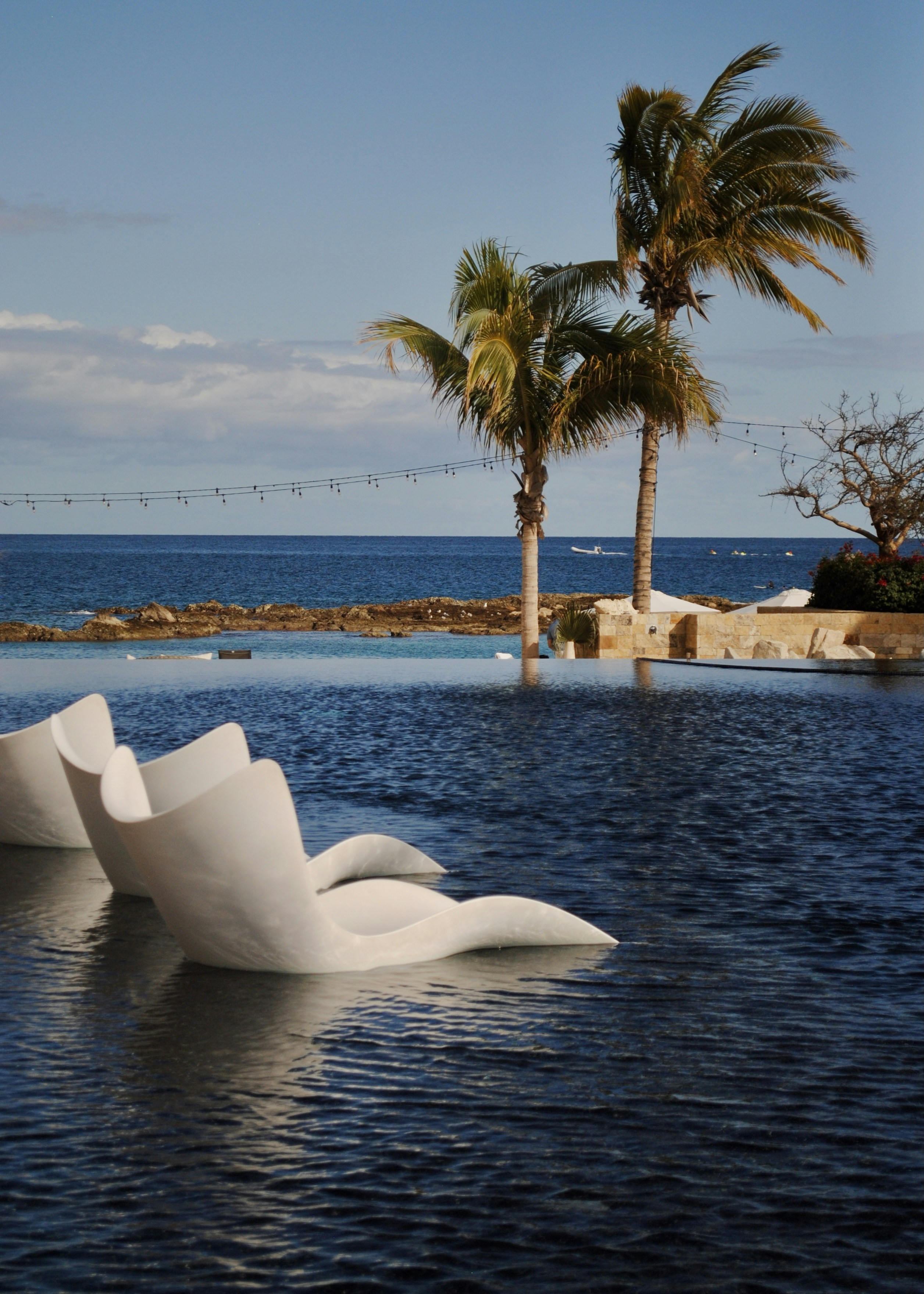 Emerald Foldings: White Chairs Emergence from Pool at Sunset Cove