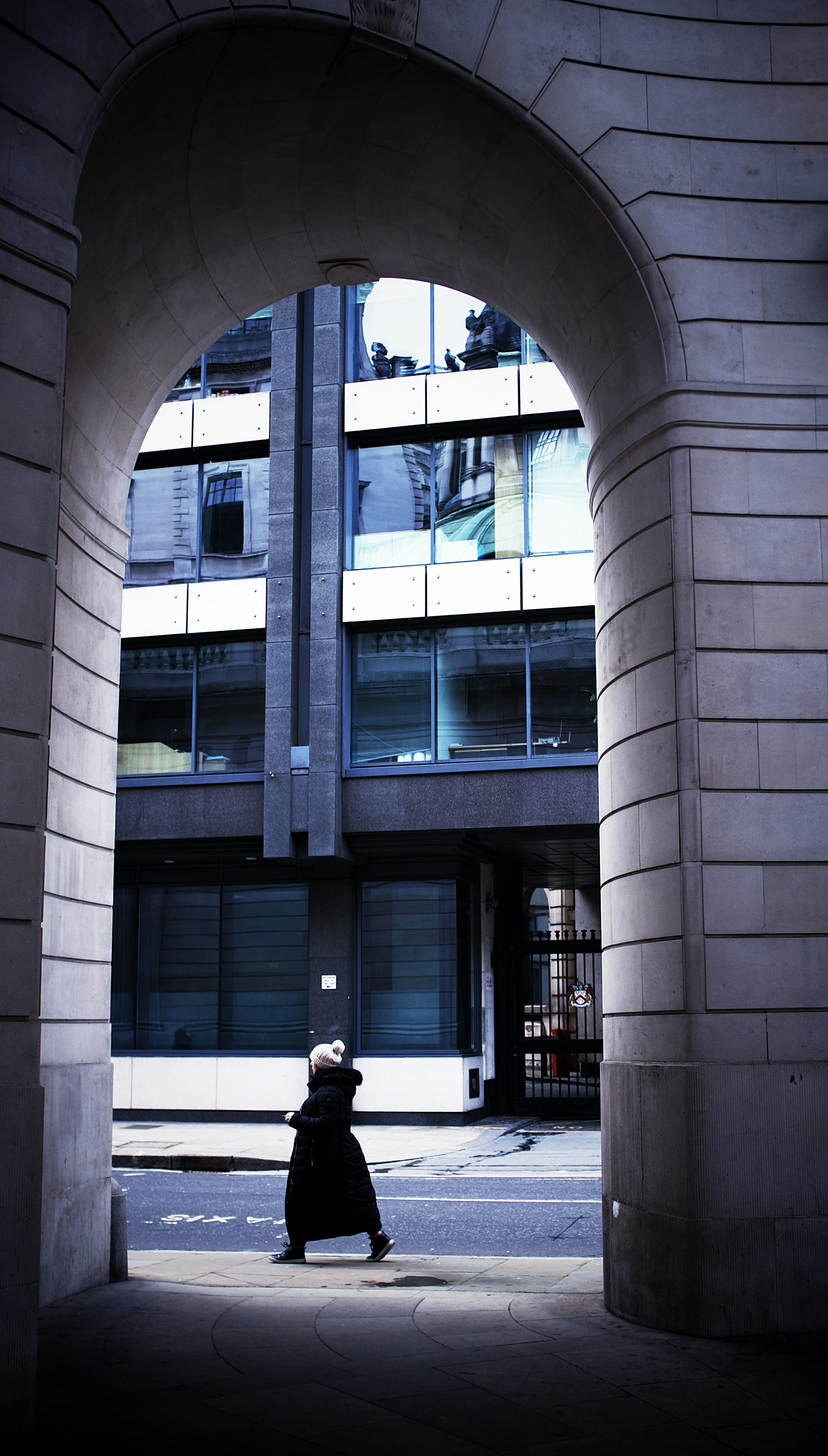Archway and Pedestrian: Framing the City in Stone and Glass