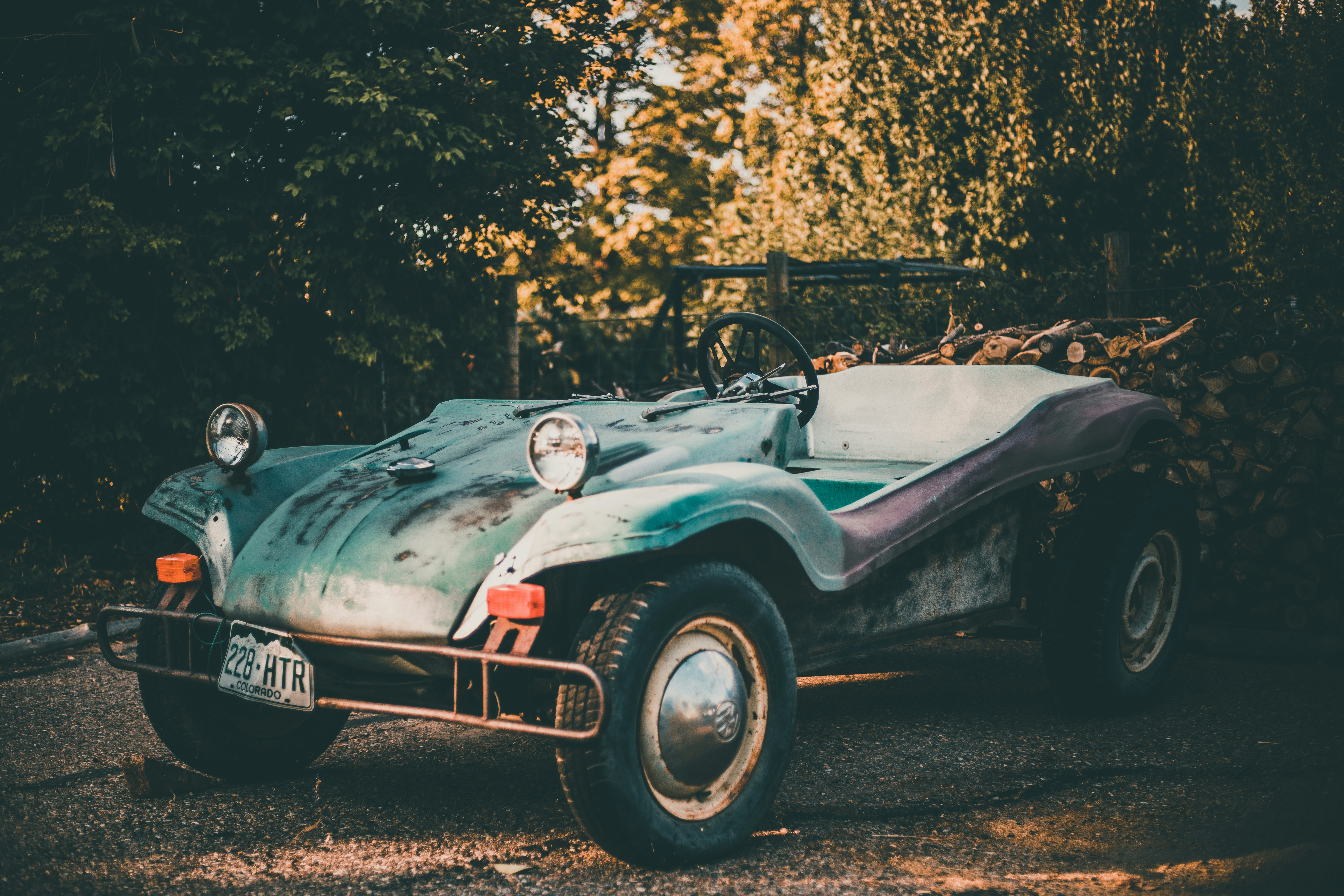 Patina-Tinted Roadster Resting Under Autumn Dappled Light