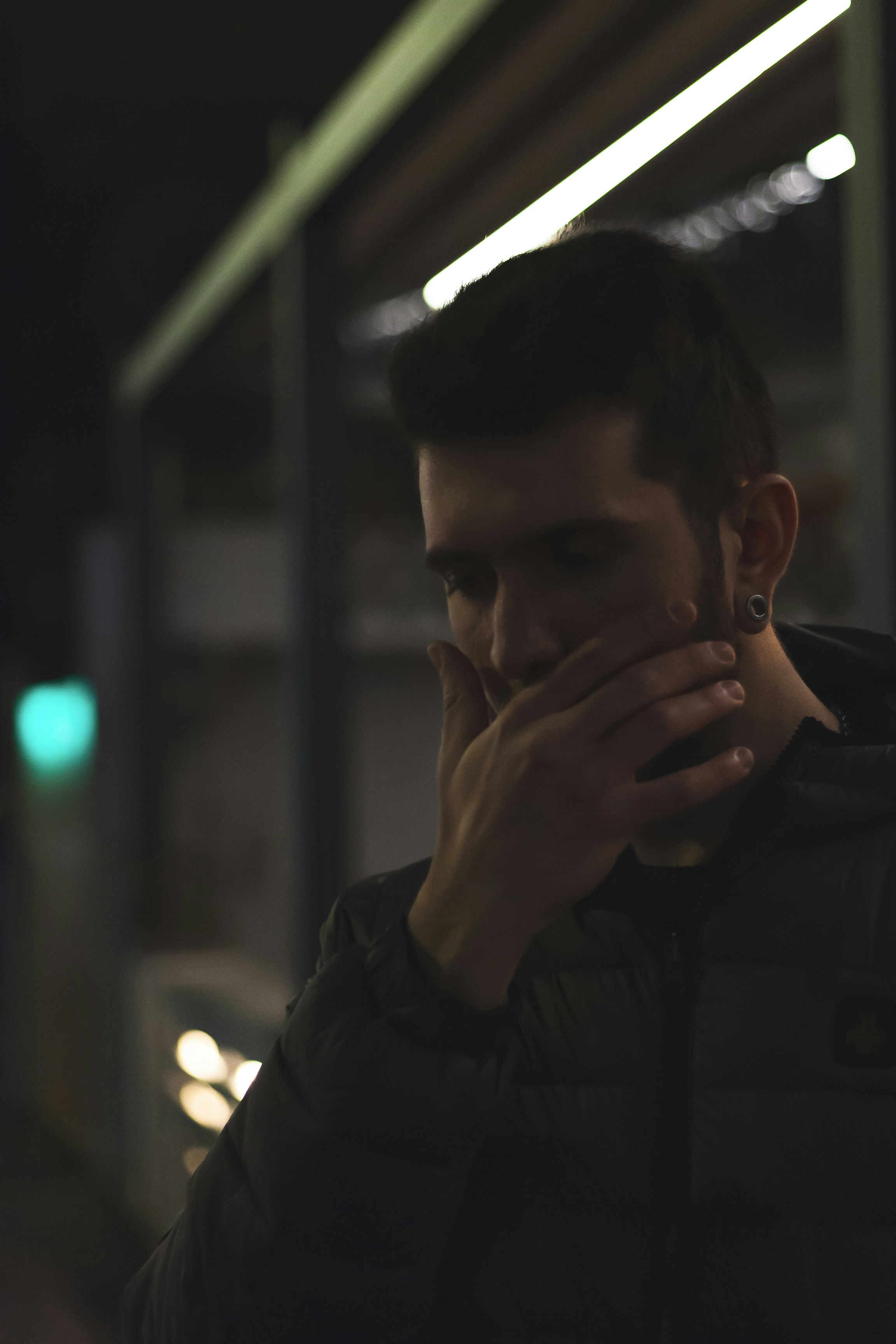 Neon Quiet: A Contemplative Portrait Beneath Subway Neon