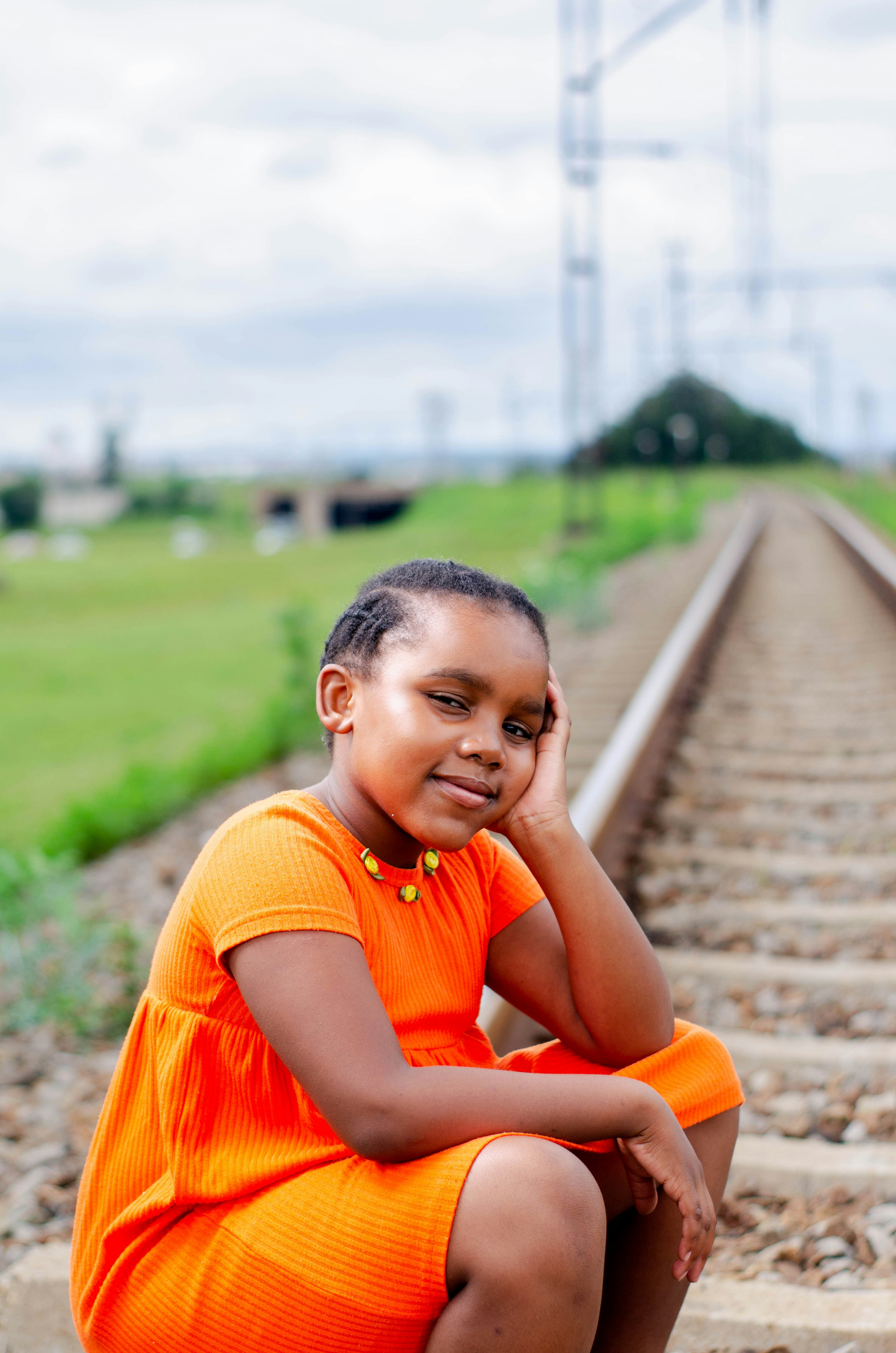 Portrait on the Rails: A Quiet Moment in Orange