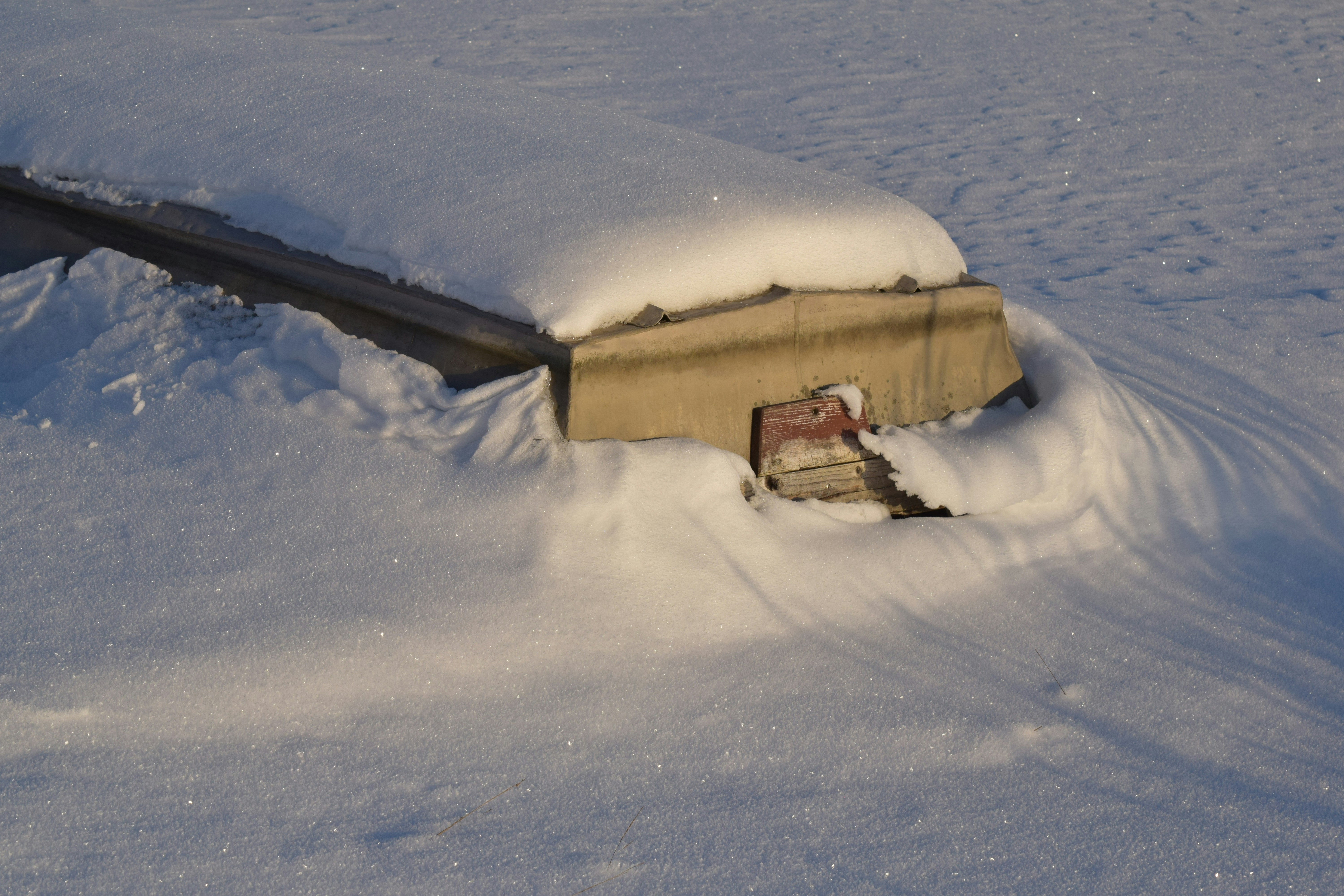 Snow-Covered Dock Edge Hidden in Light