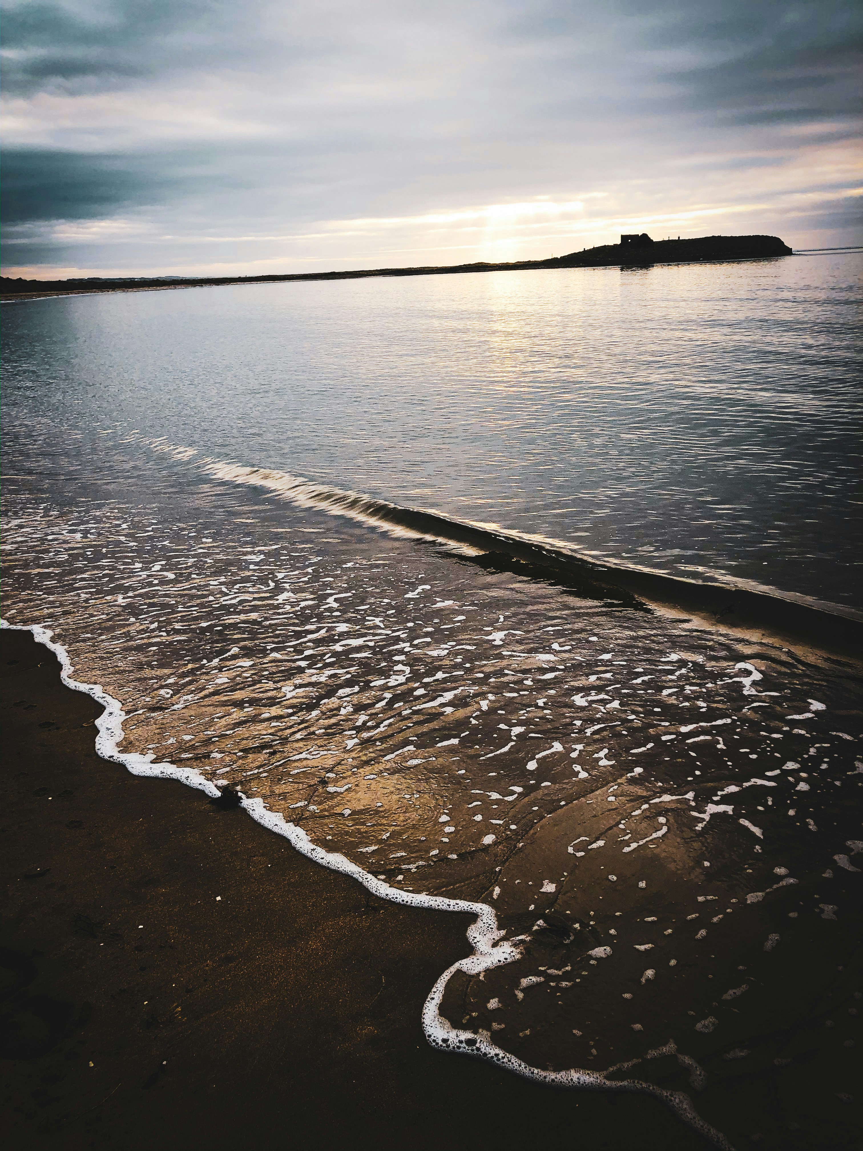 Body of water near shore during daytime photo – Free Sunset Image on ...