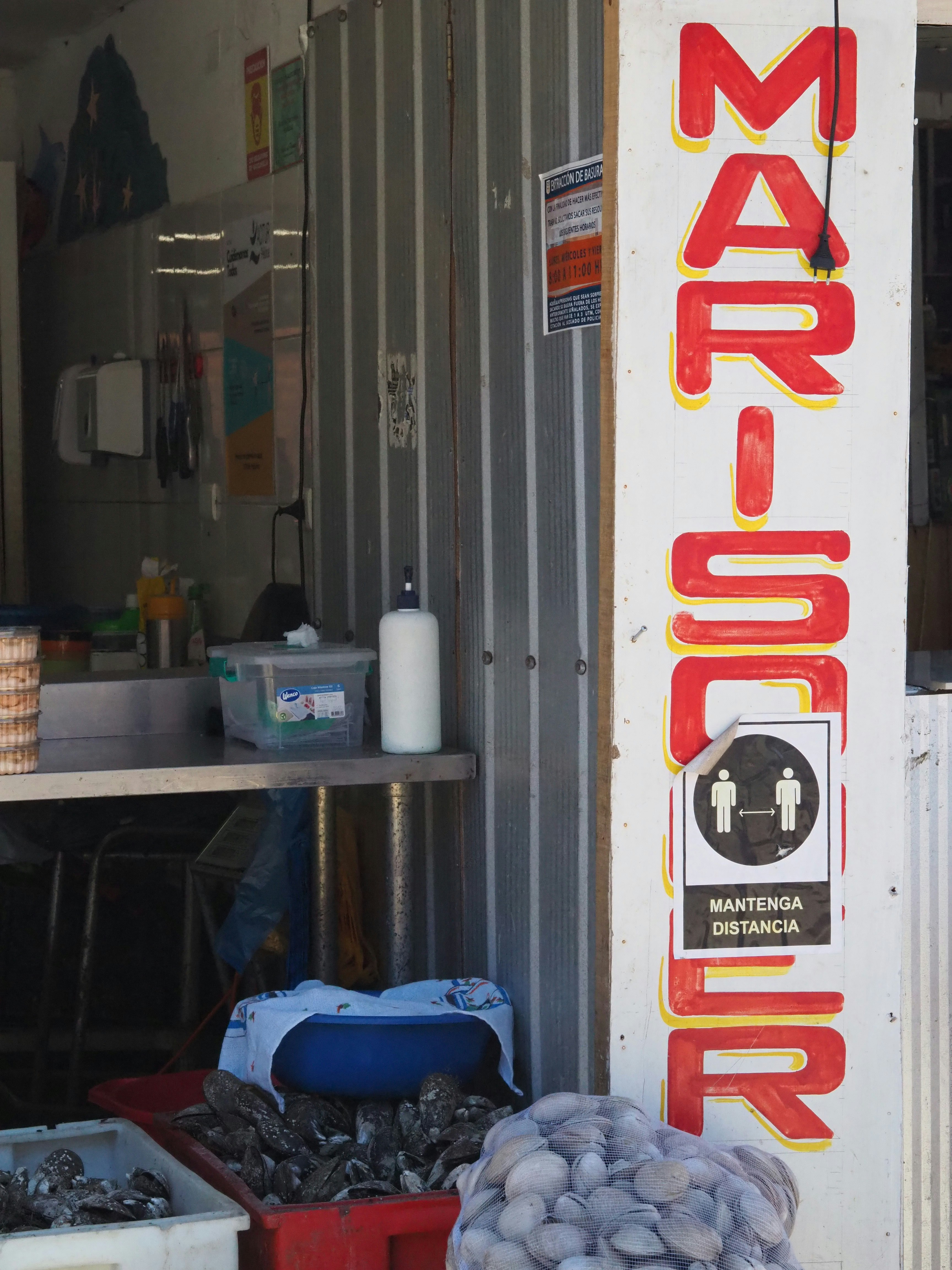 Marisco's Vertical Beacon: A Seafood Stall's Bold Sign