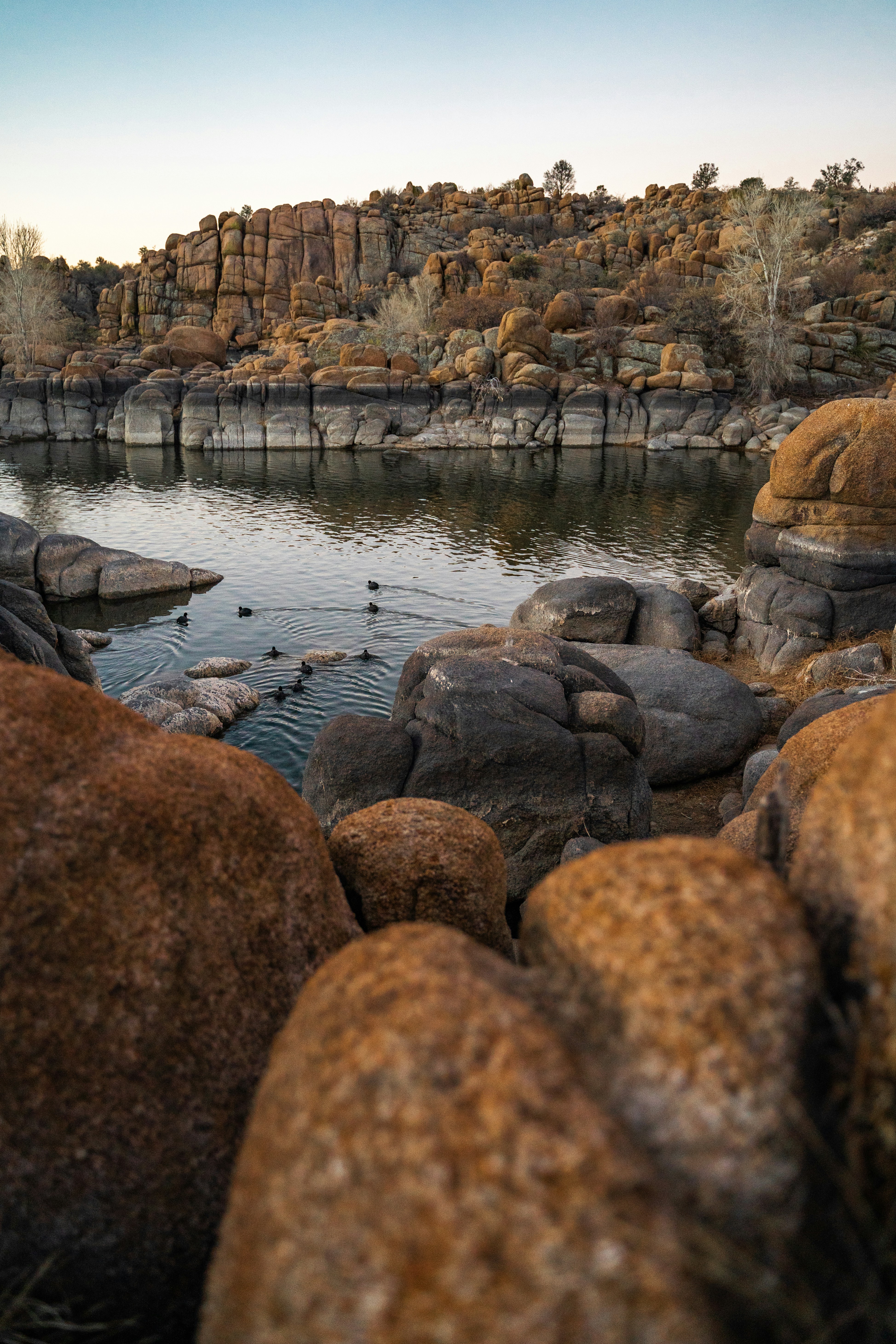Granite Tides: Quiet Lake Walled by Weathered Boulders
