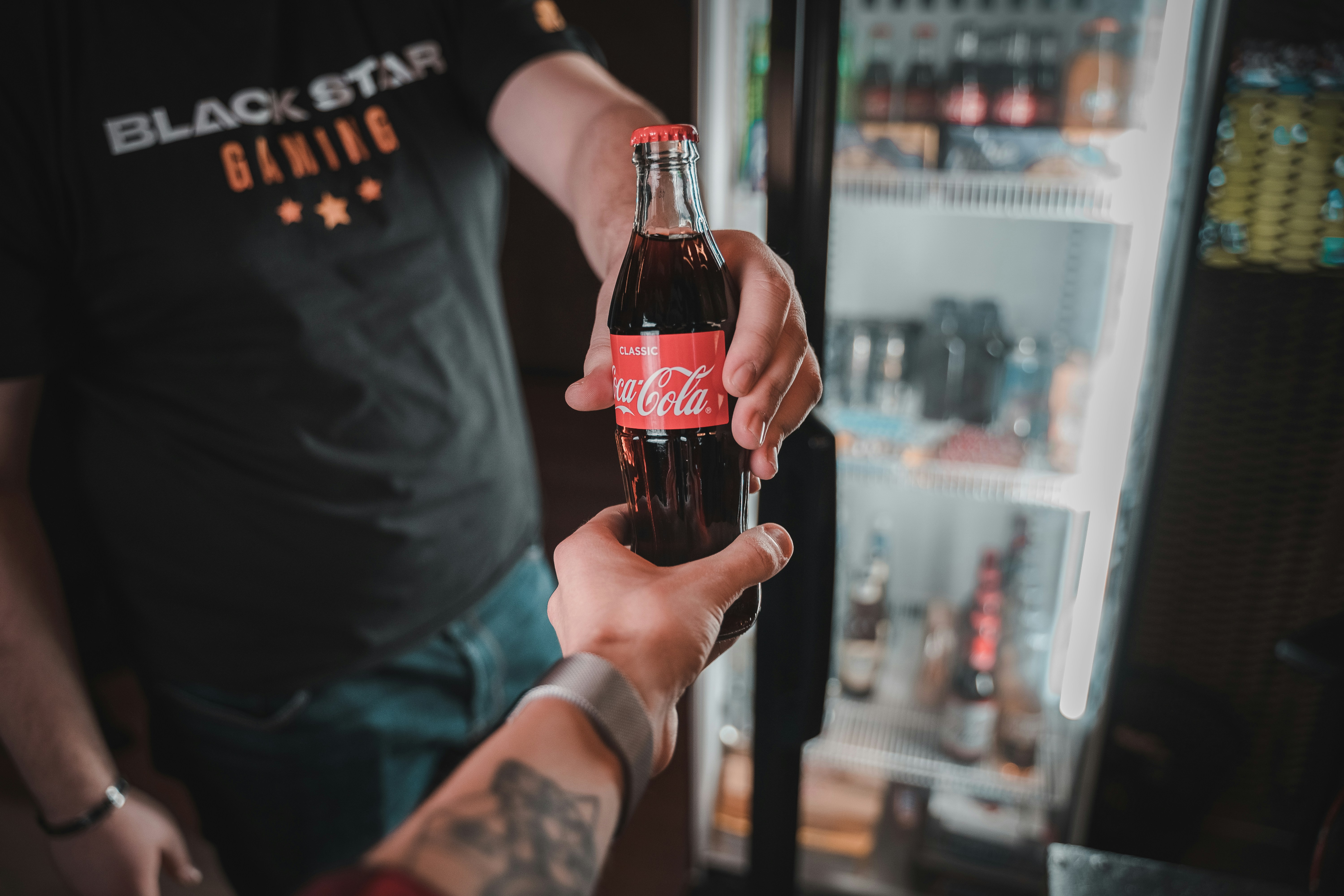 Persona sosteniendo una botella de Coca Cola foto – Imagen de Humano ...