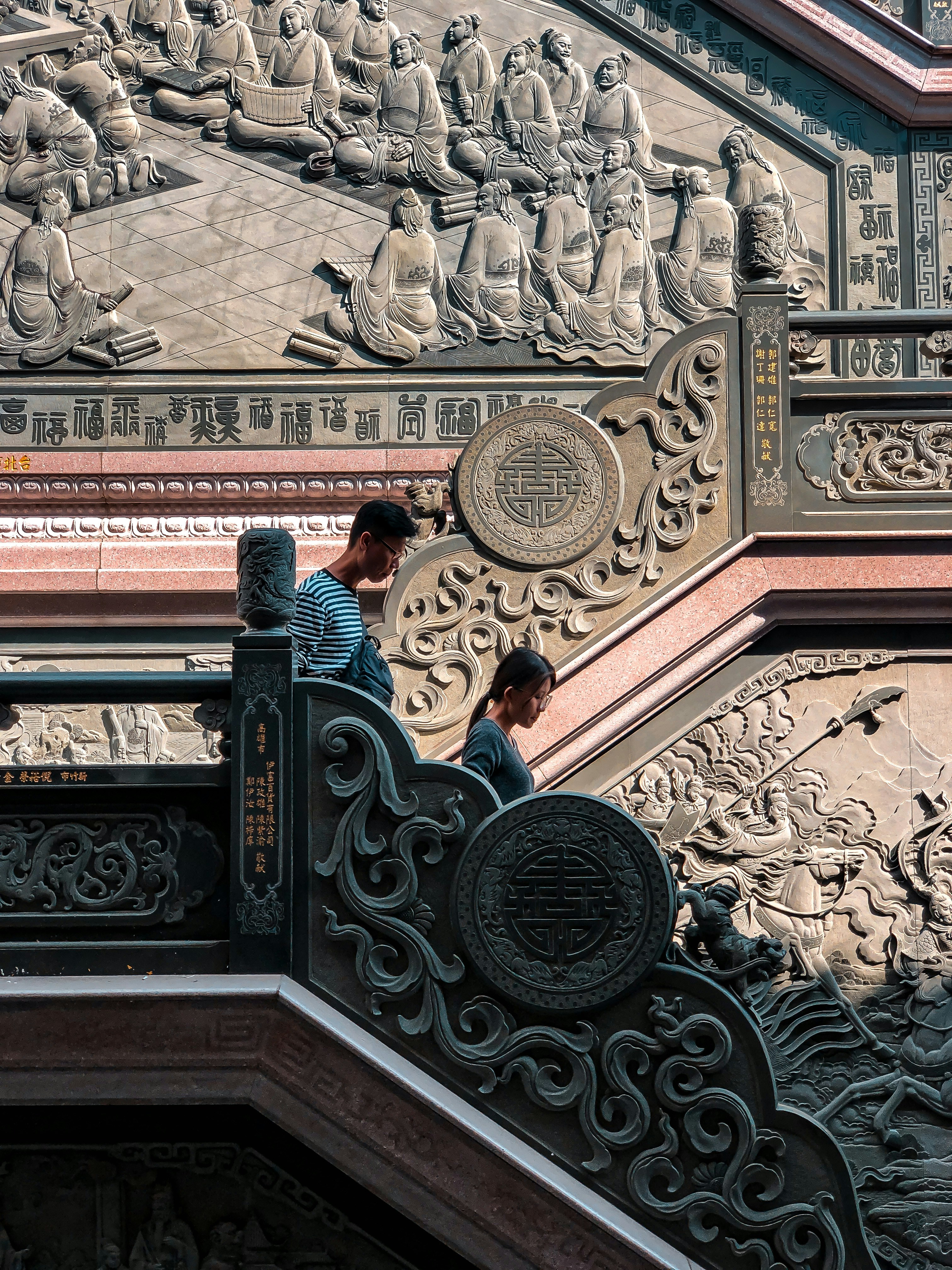 Carved Staircase Stories: Visitors Pause Amid Heritage Reliefs