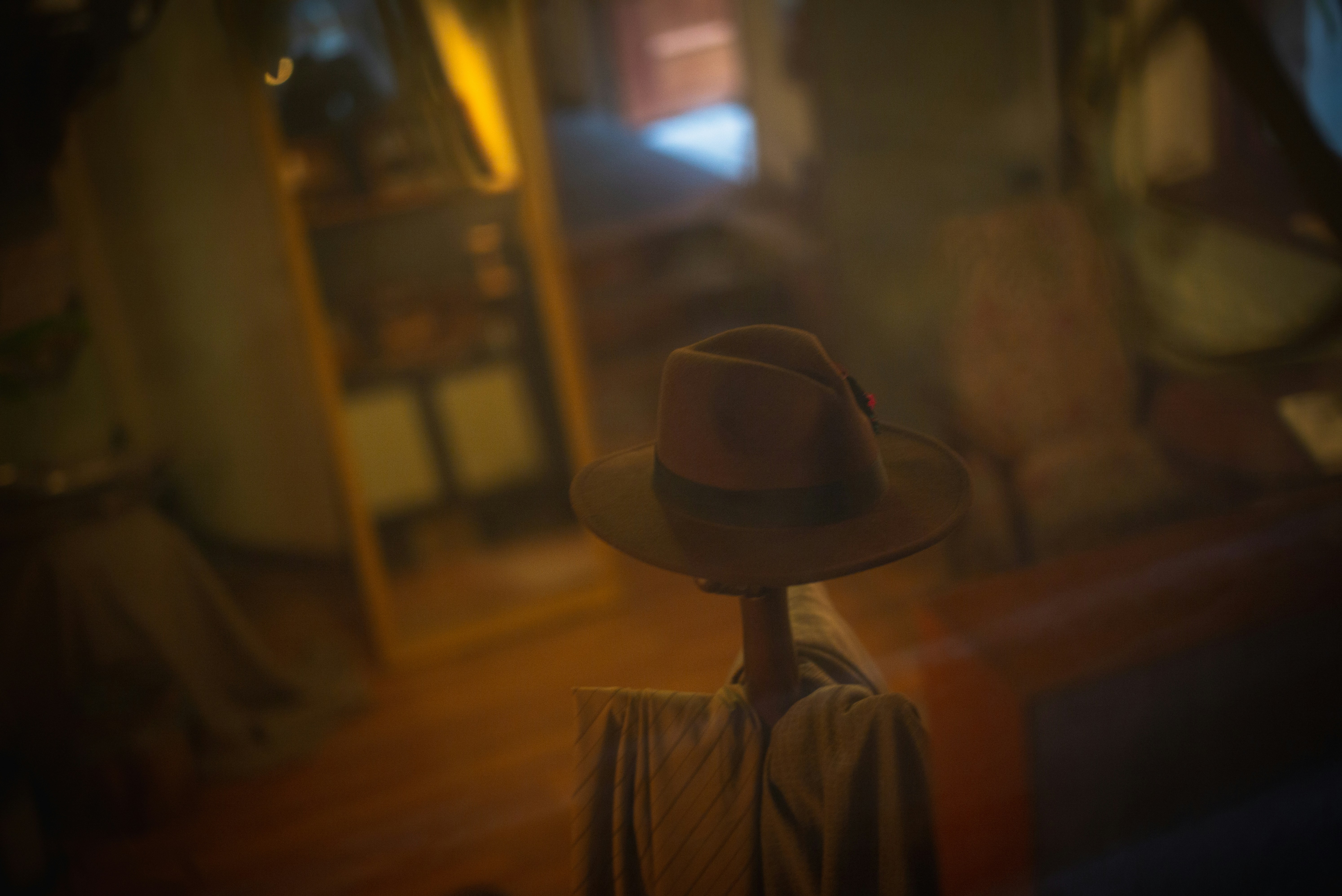 Fedora in the Glow: A Quiet Shop Window Portrait