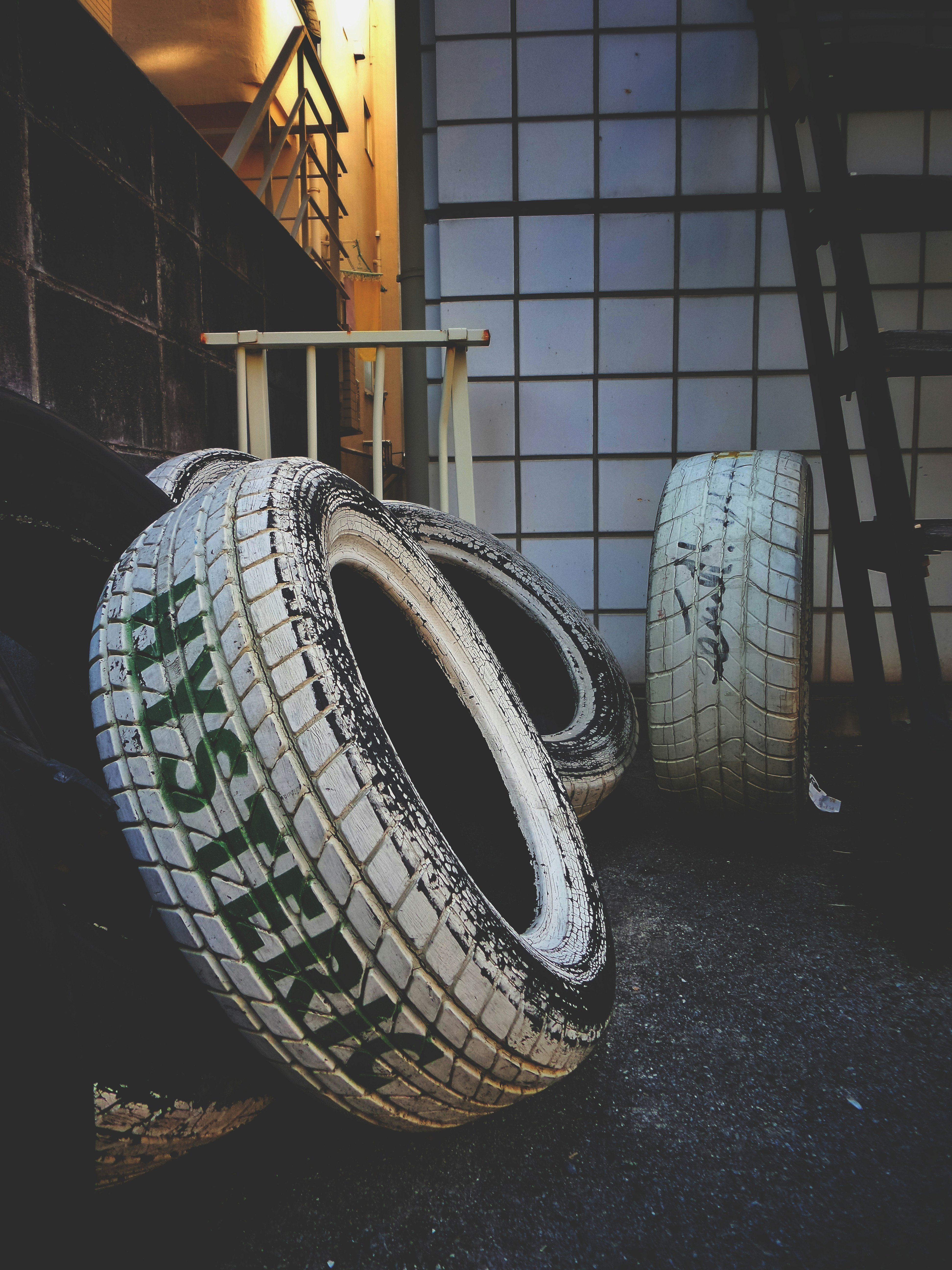Tire Portraits in a Dim Garage Corner
